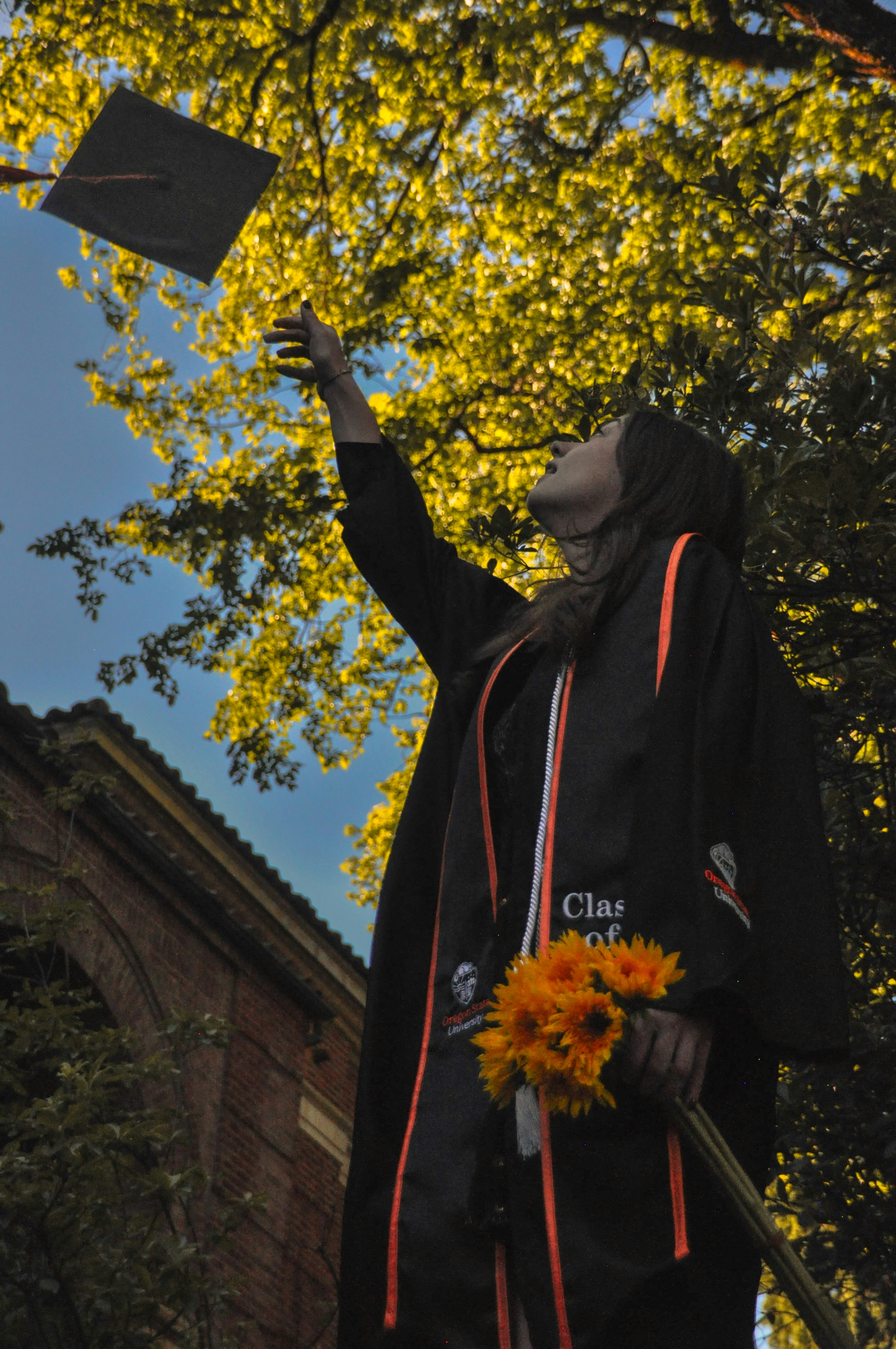Graduate in Flight: Tossing the Cap Beneath Golden Trees