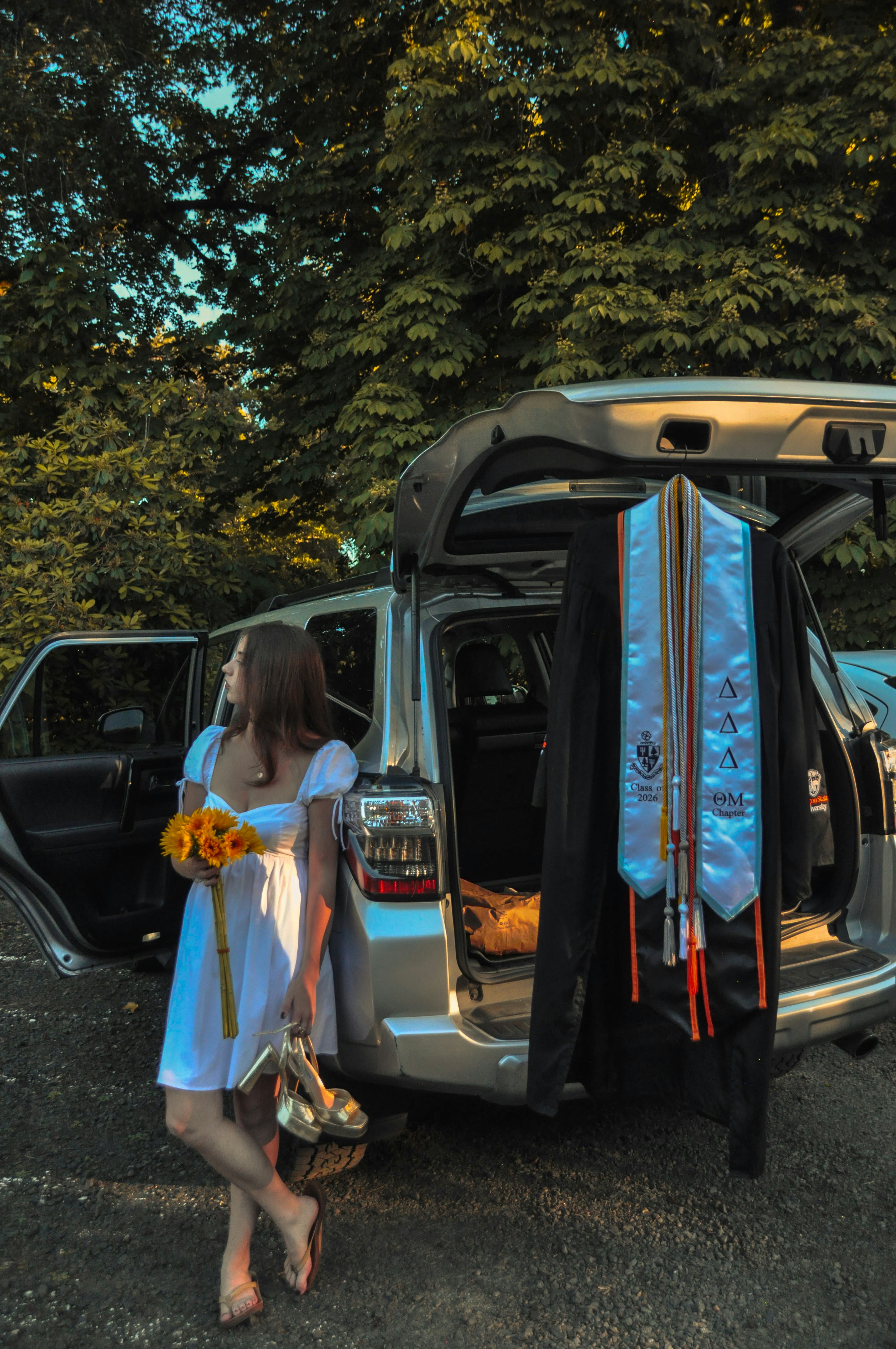 Sunlit Bouquet and Graduation Gear by the Open Hatch
