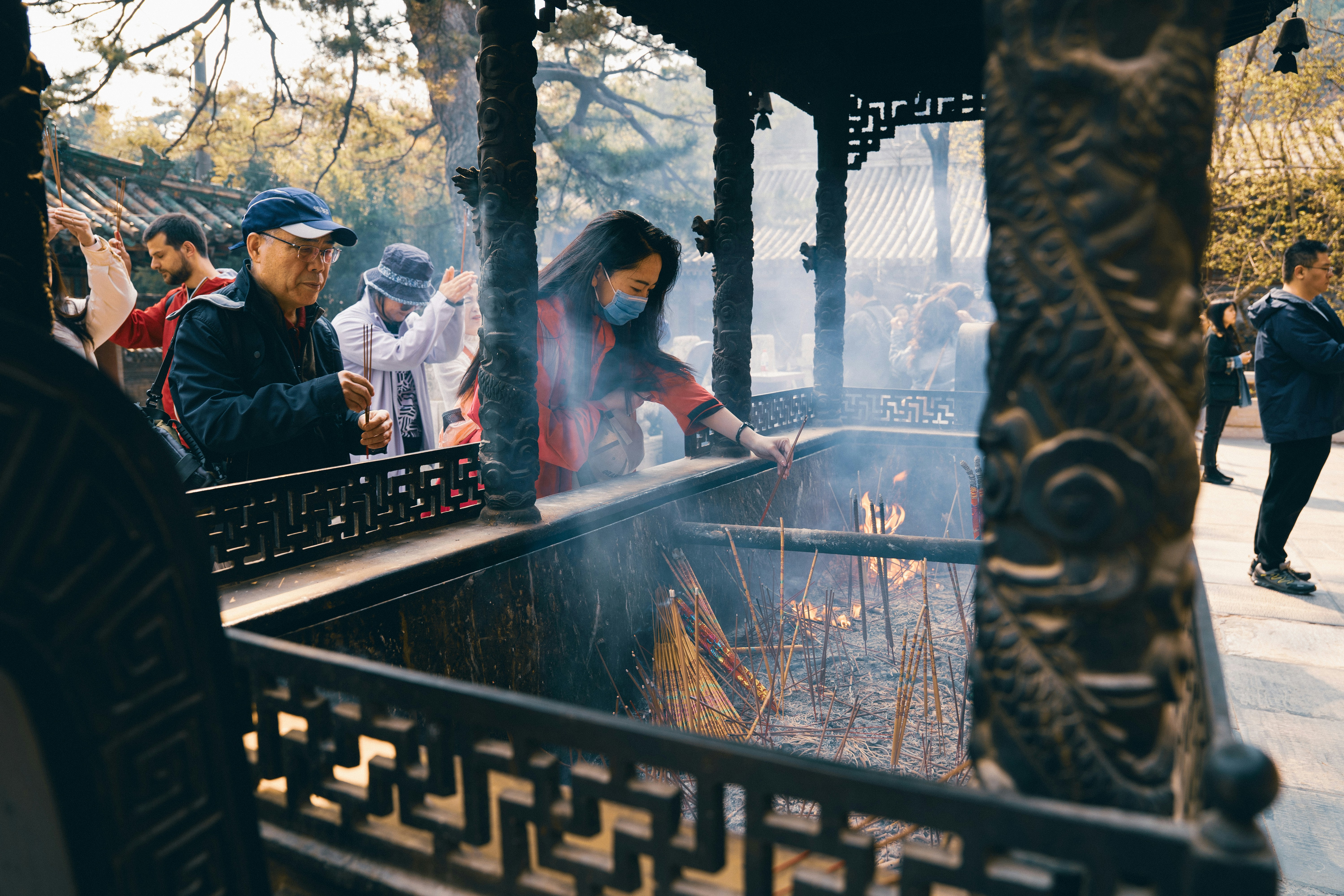 Offering Flames Amid Ancient Carvings