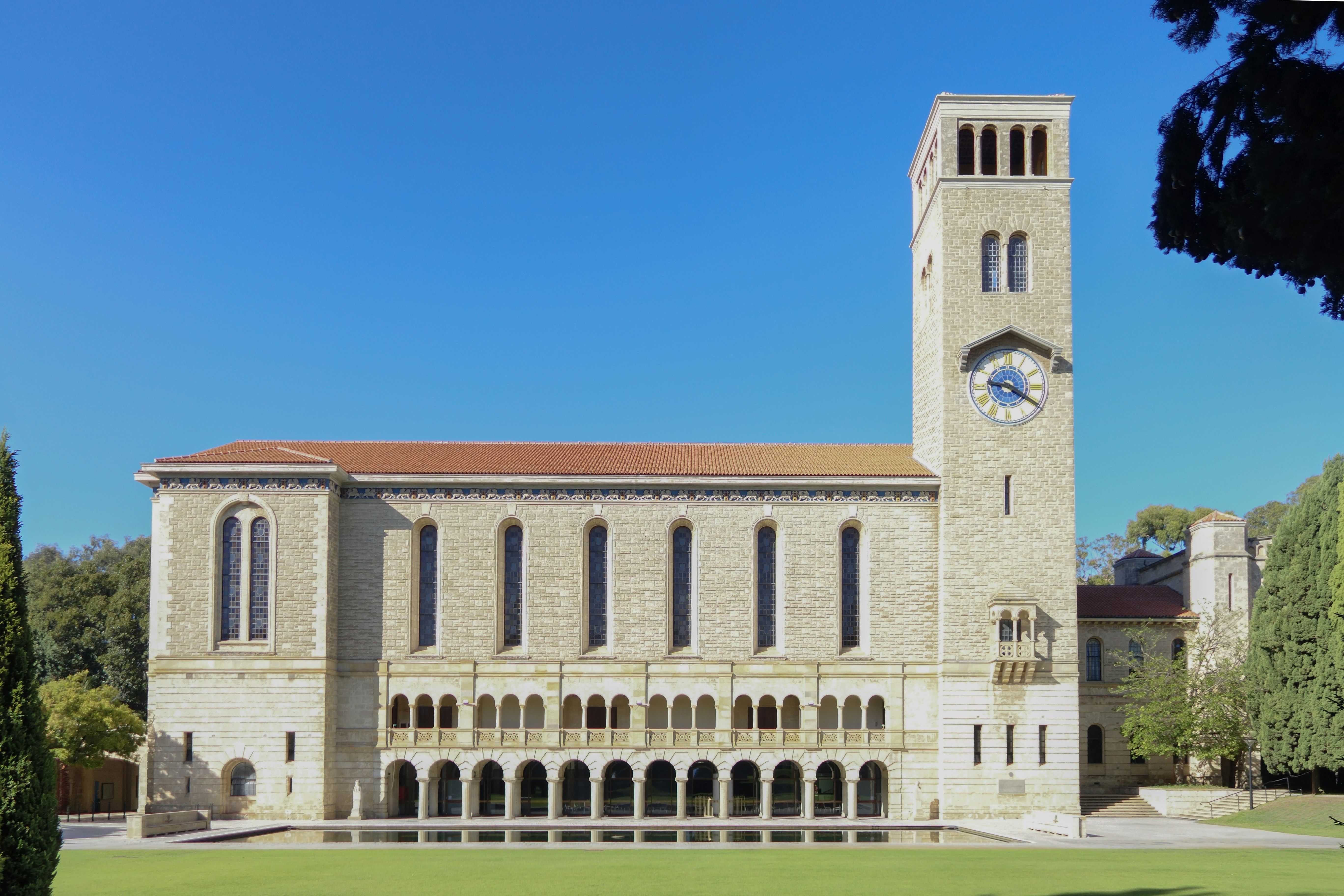 Stone Tower and Clock: A Sunny Campus Facade