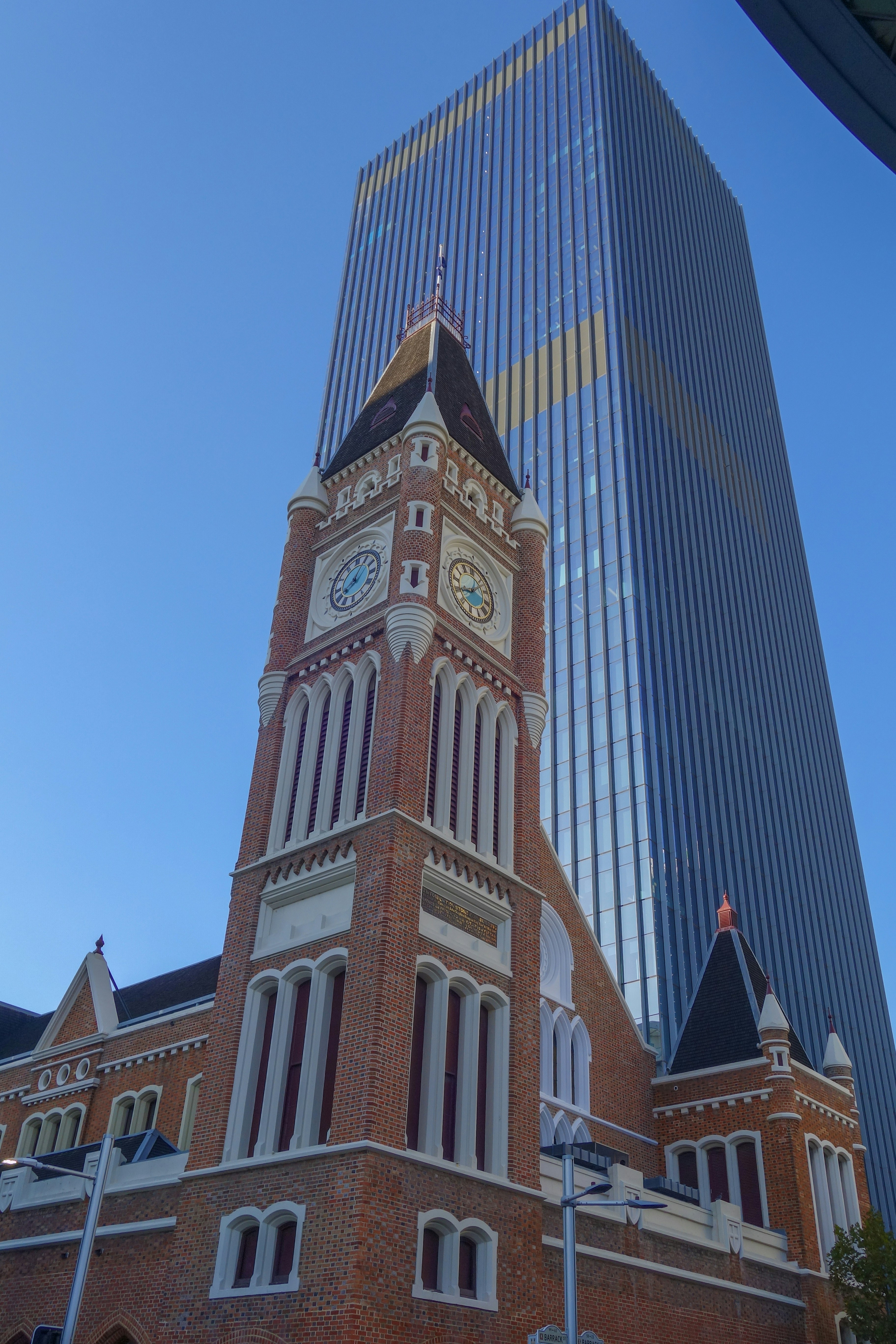 Clock Tower Against Glass Curtain: Historic Facade Meets Modern Skyline