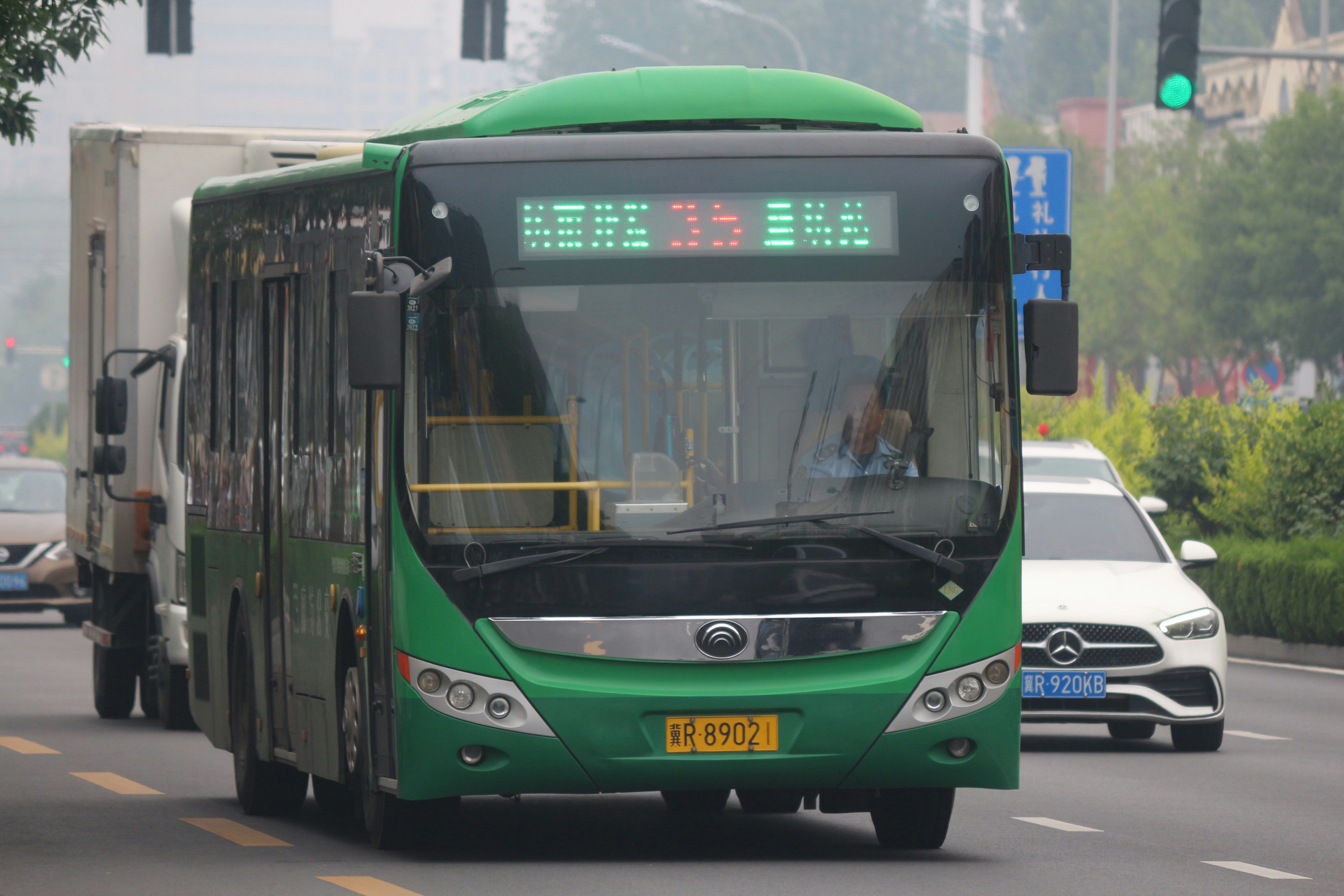 Green City Bus Approaching: Urban Commute Under Soft Morning Light