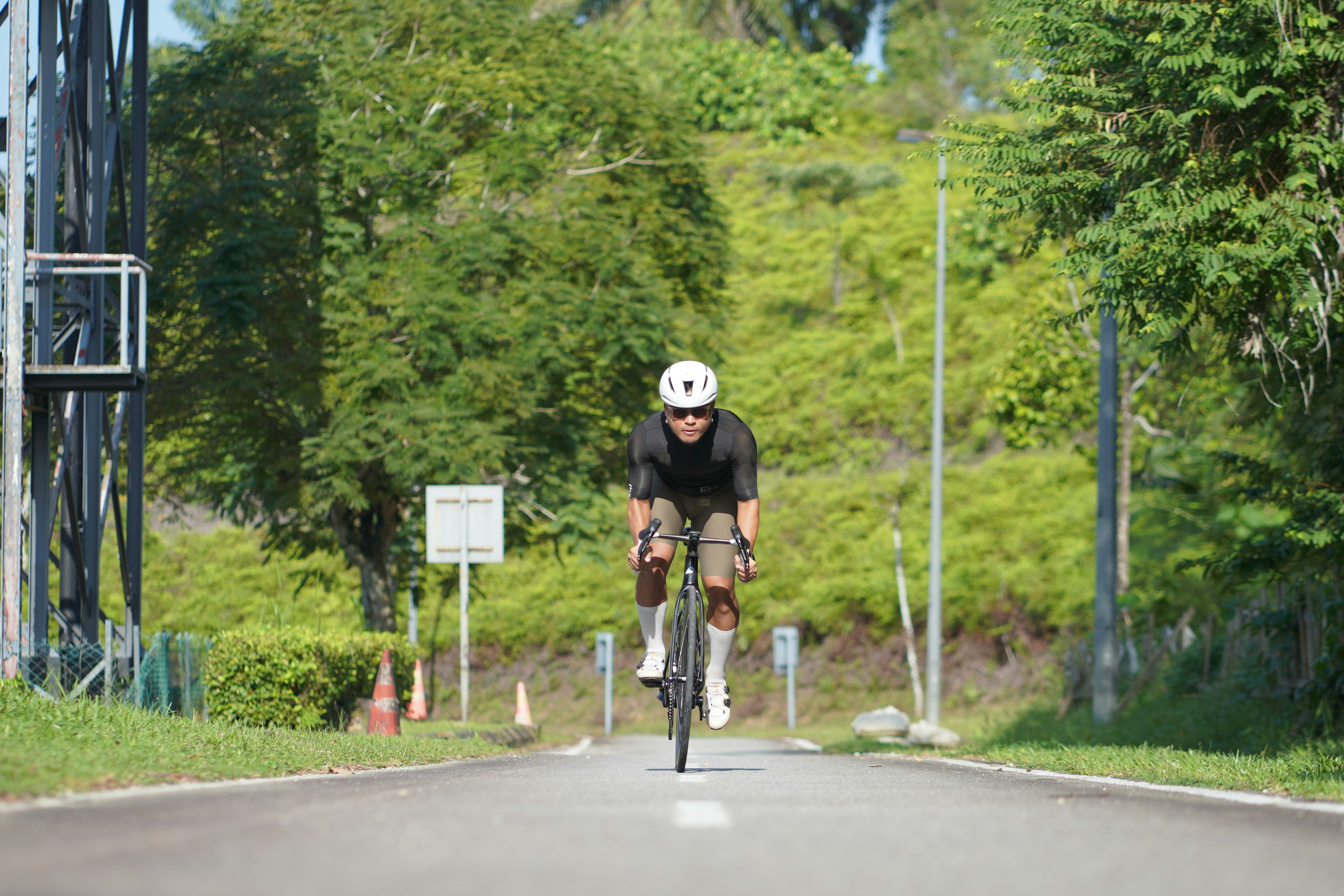 Centered Rider: Focus on the Helmeted Cyclist Surging Toward the Camera