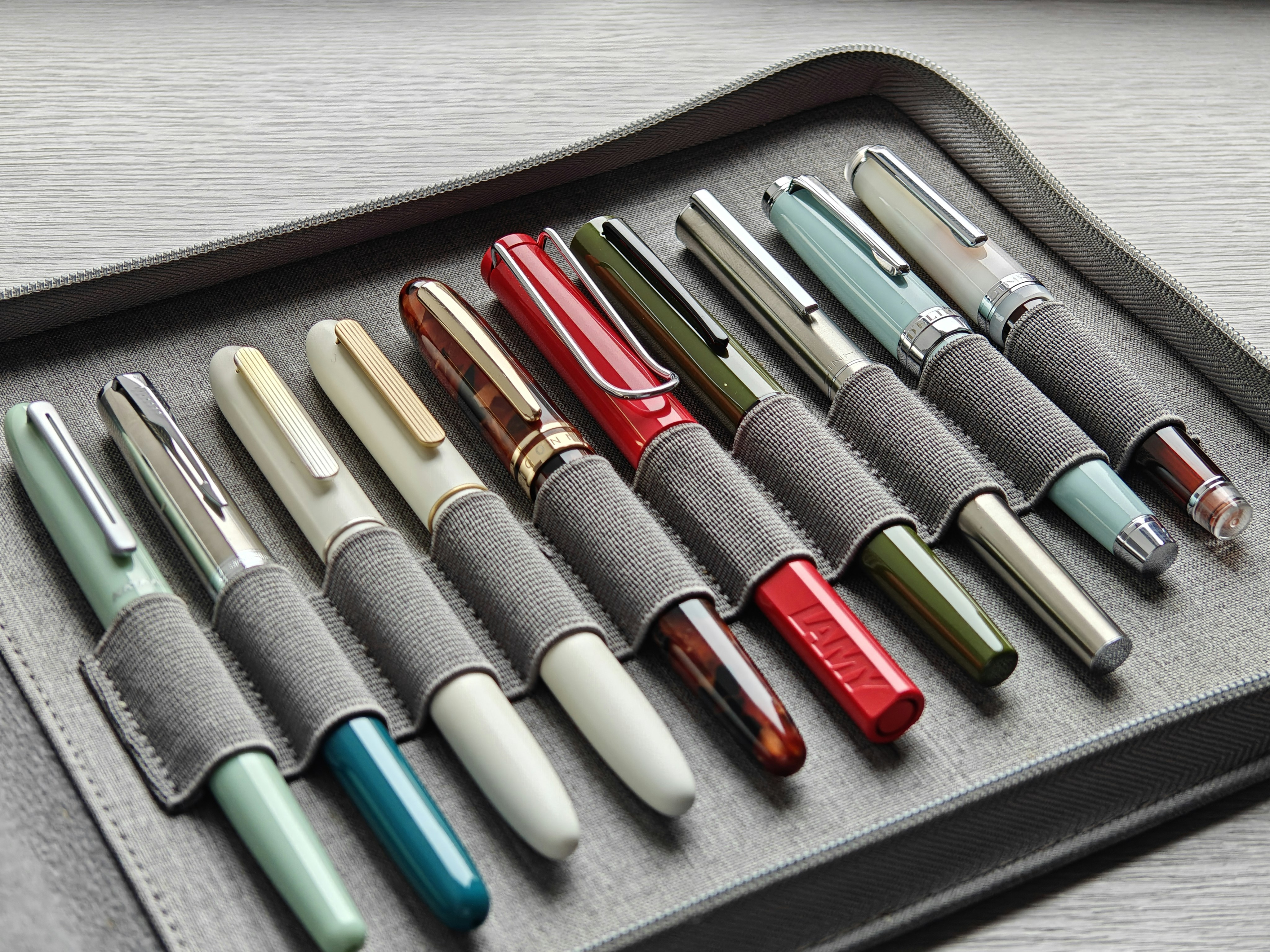 A Row of Painted Pens in a Leather Tray
