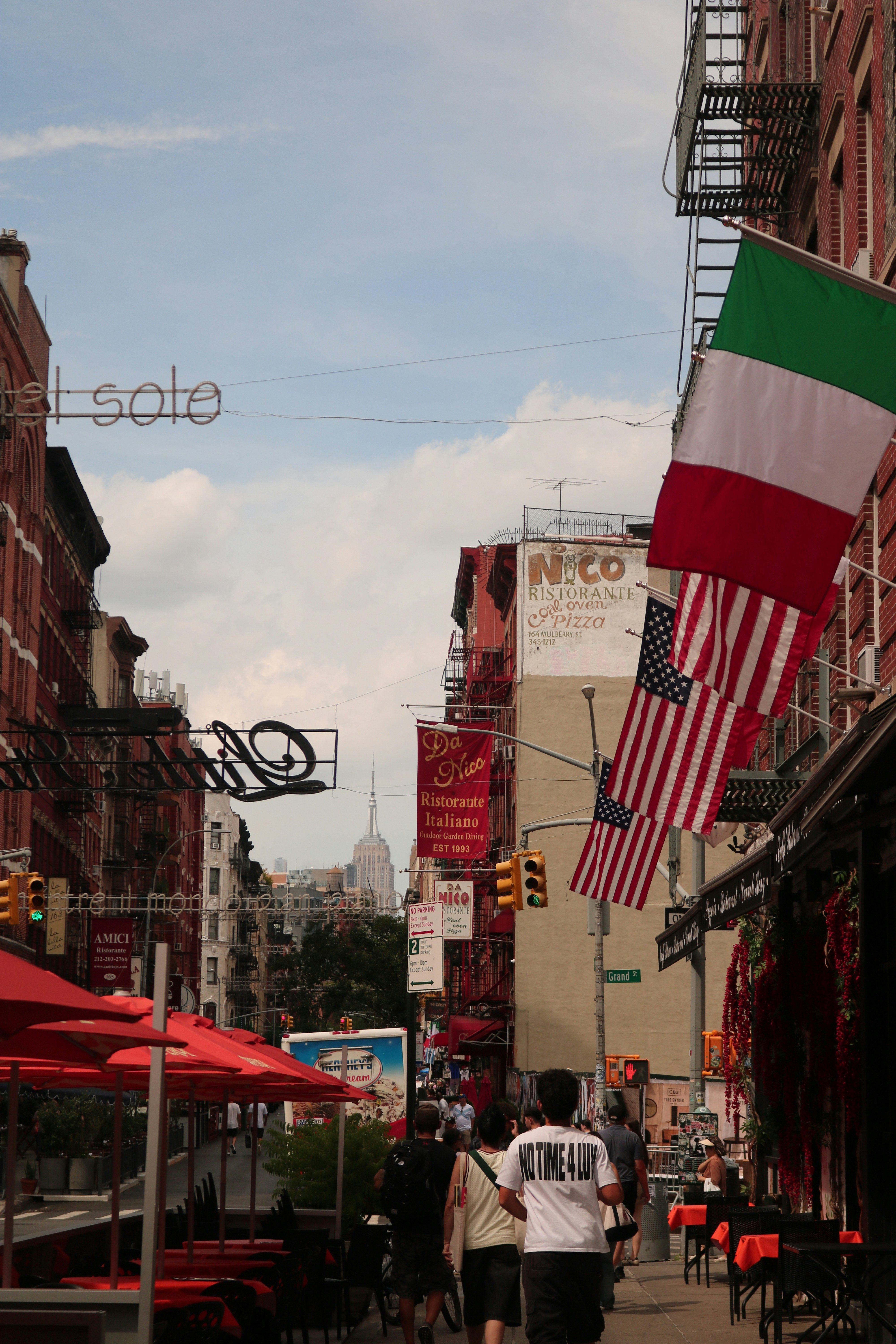 Italian Flag Over a Bustling City Street
