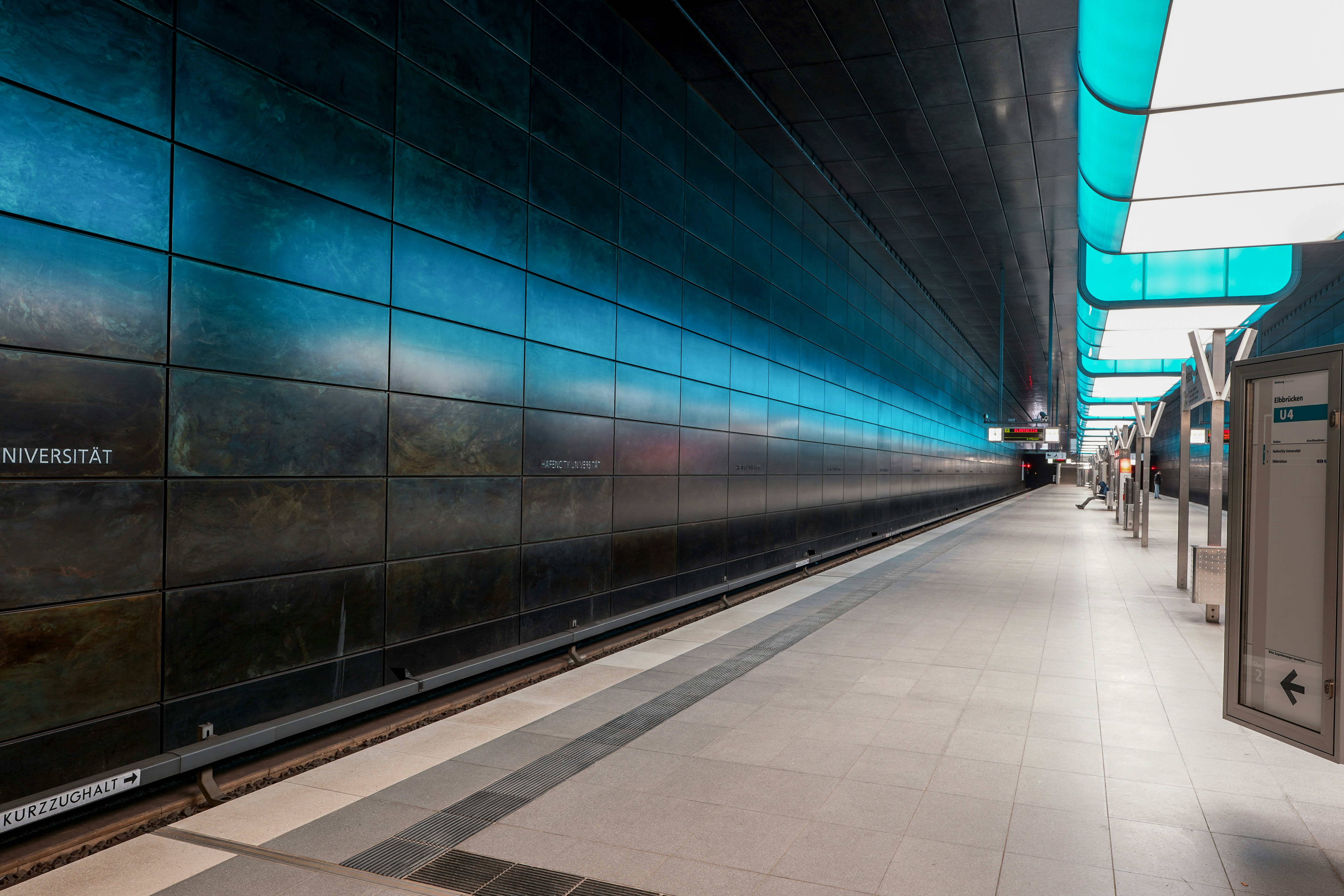 Blue neon over a quiet metro tunnel
