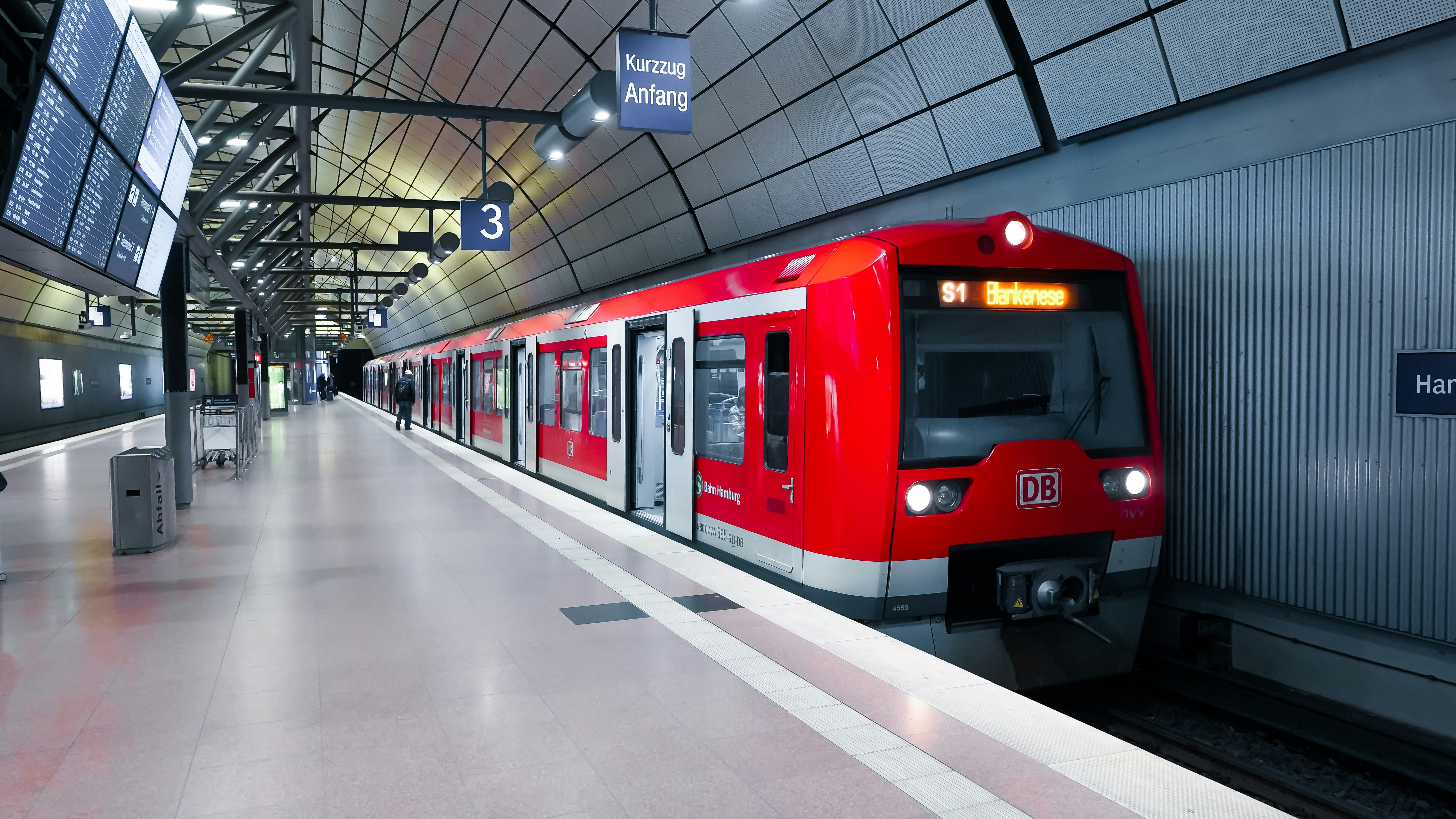 Red commuter in a modern Berlin-style underground station