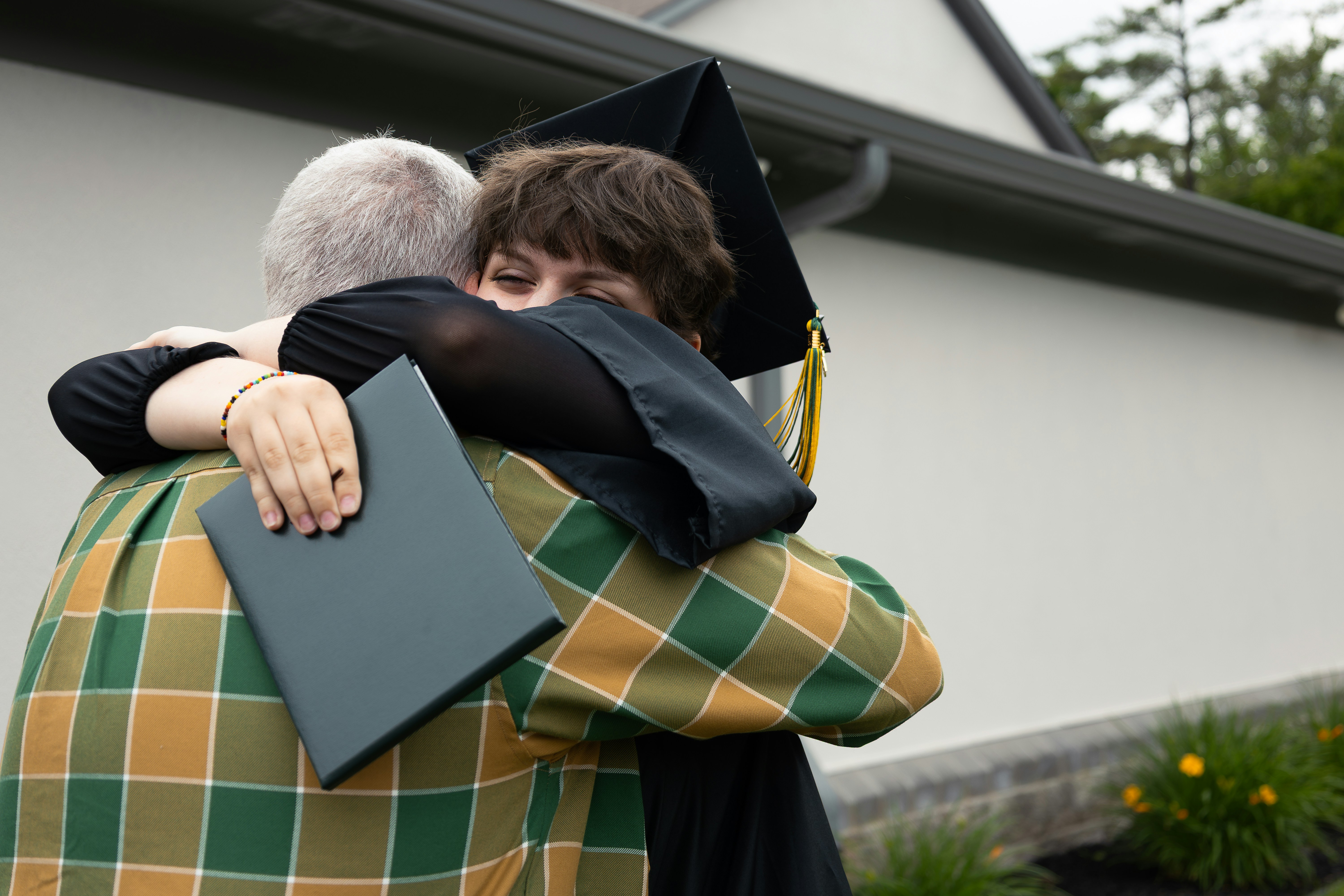 A Graduate's Embrace: Shared Triumph Beyond the Cap