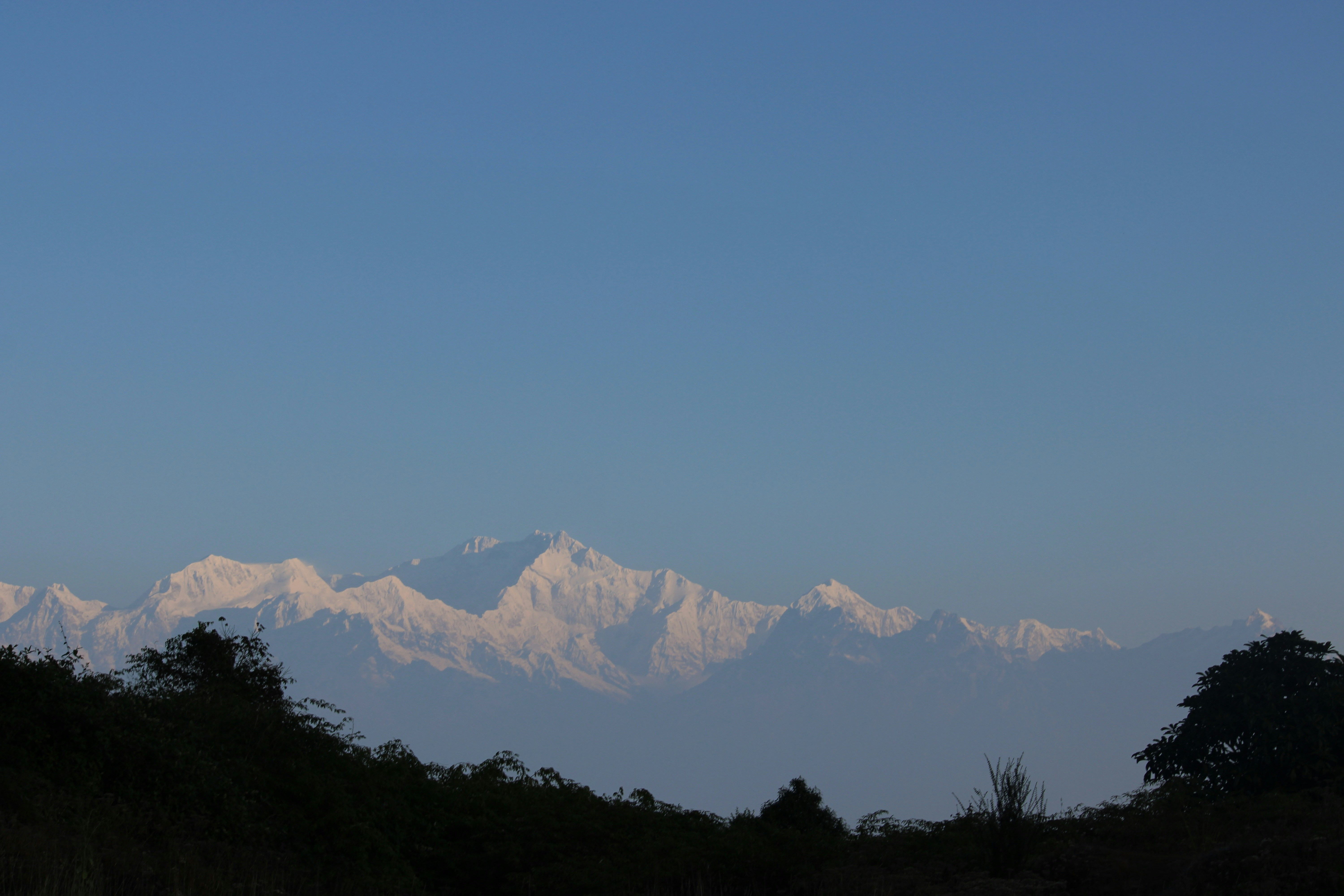 Distant Alpine Silhouette Under a Clear Blue Canopy