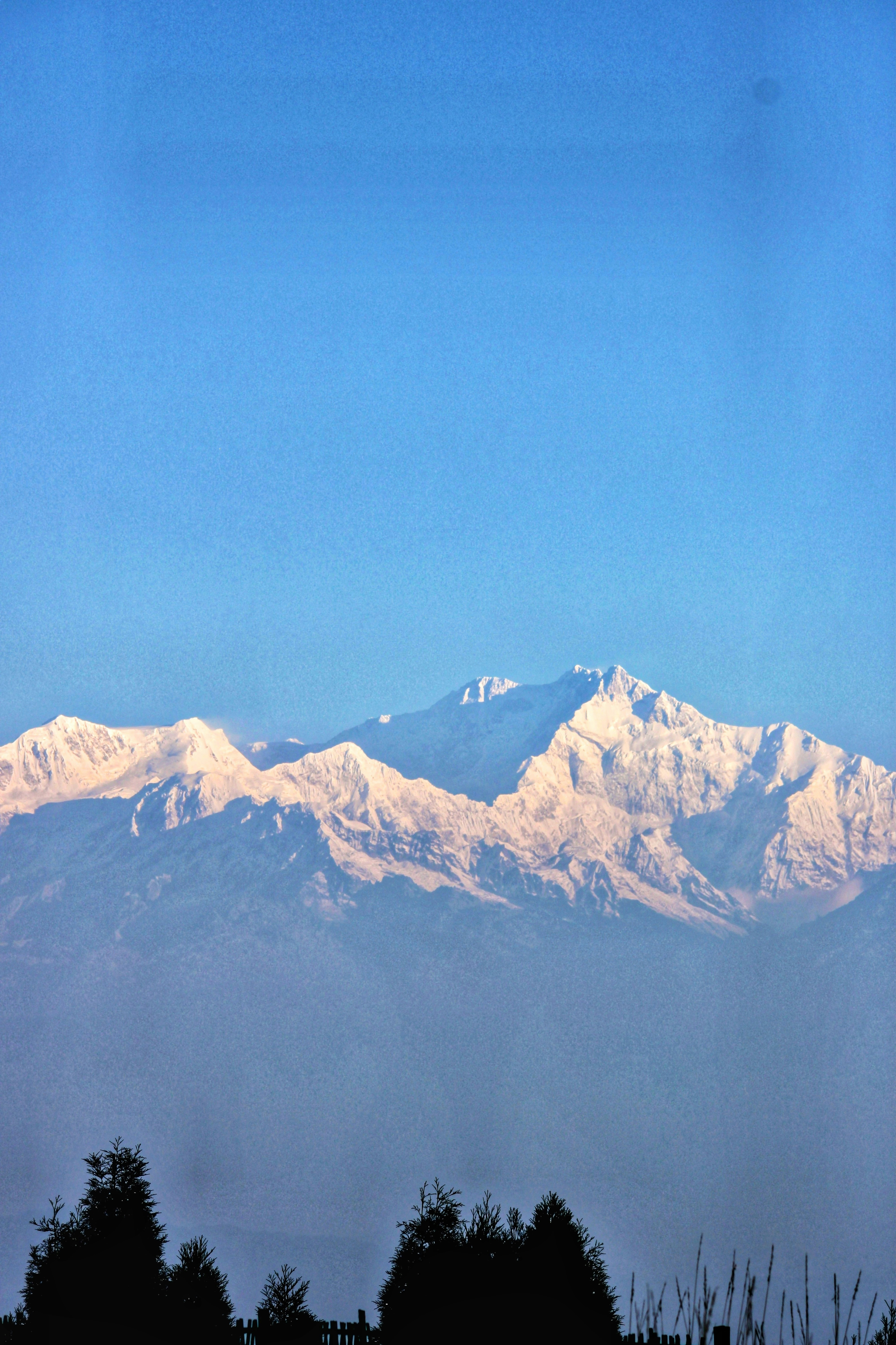 Alpine Silhouette Under a Clear Blue Sea