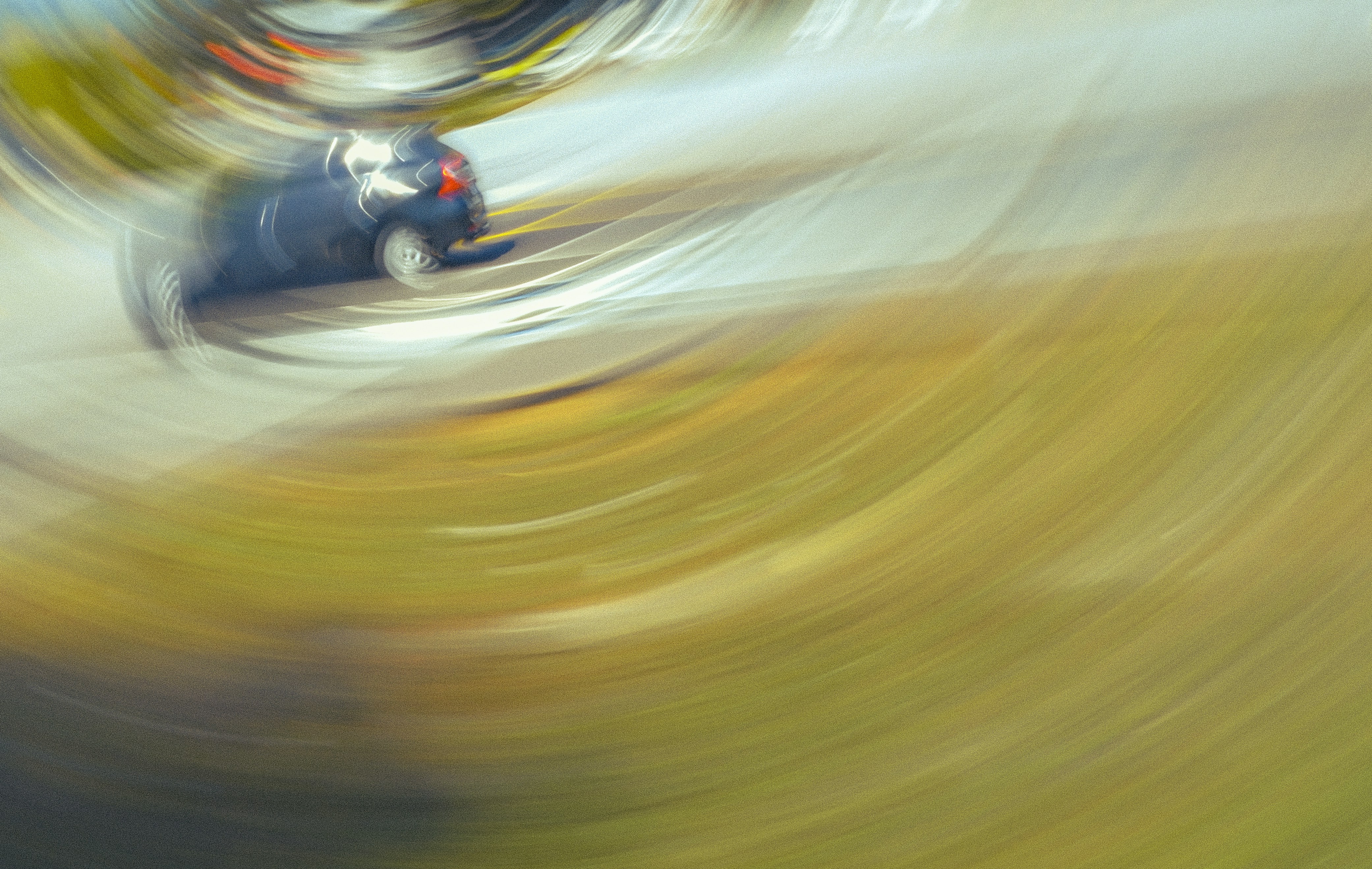 Spiraling Motion: a cyclist in a blurred, dizzying swirl