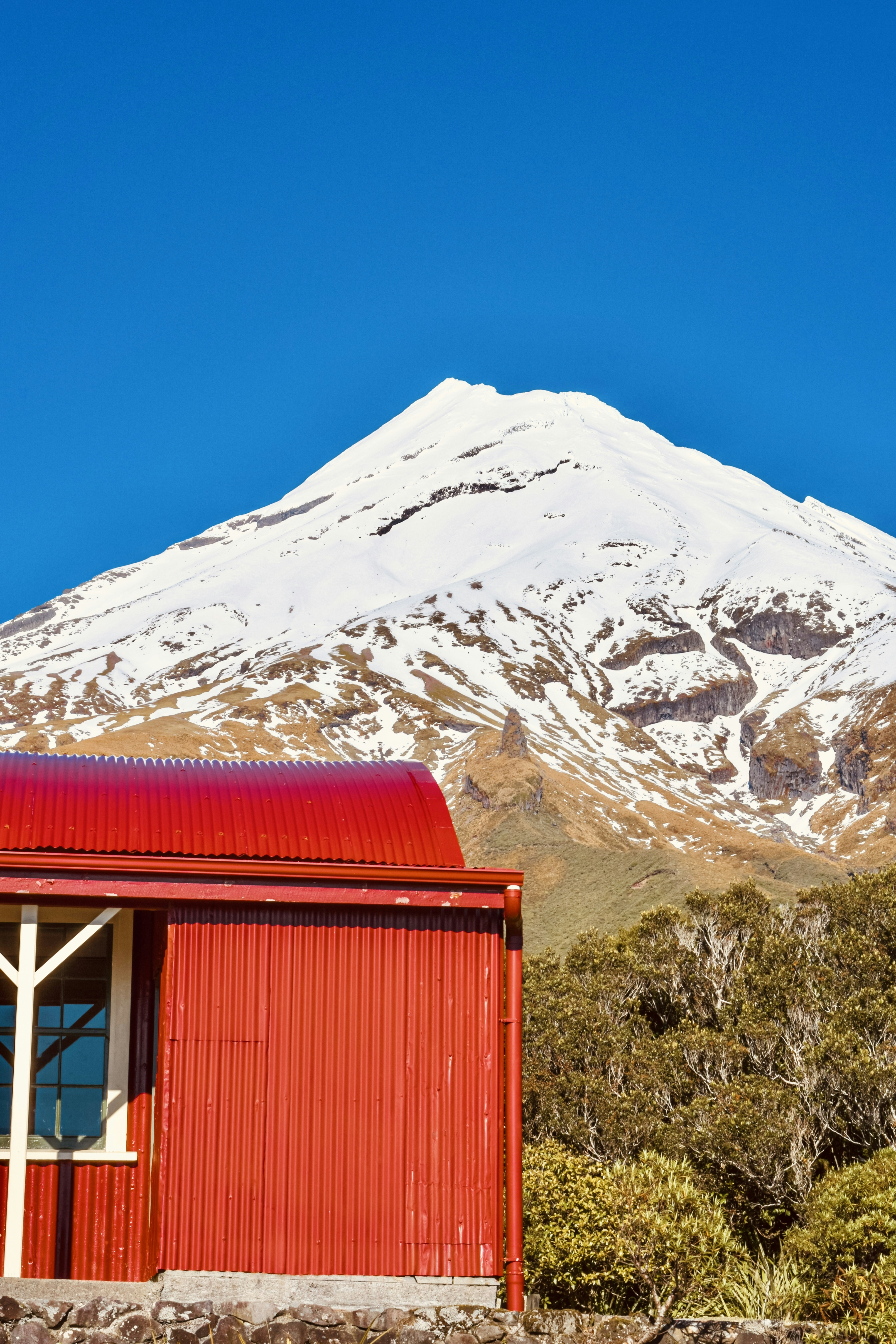 Red House at the Foot of a Snow-Capped Peak