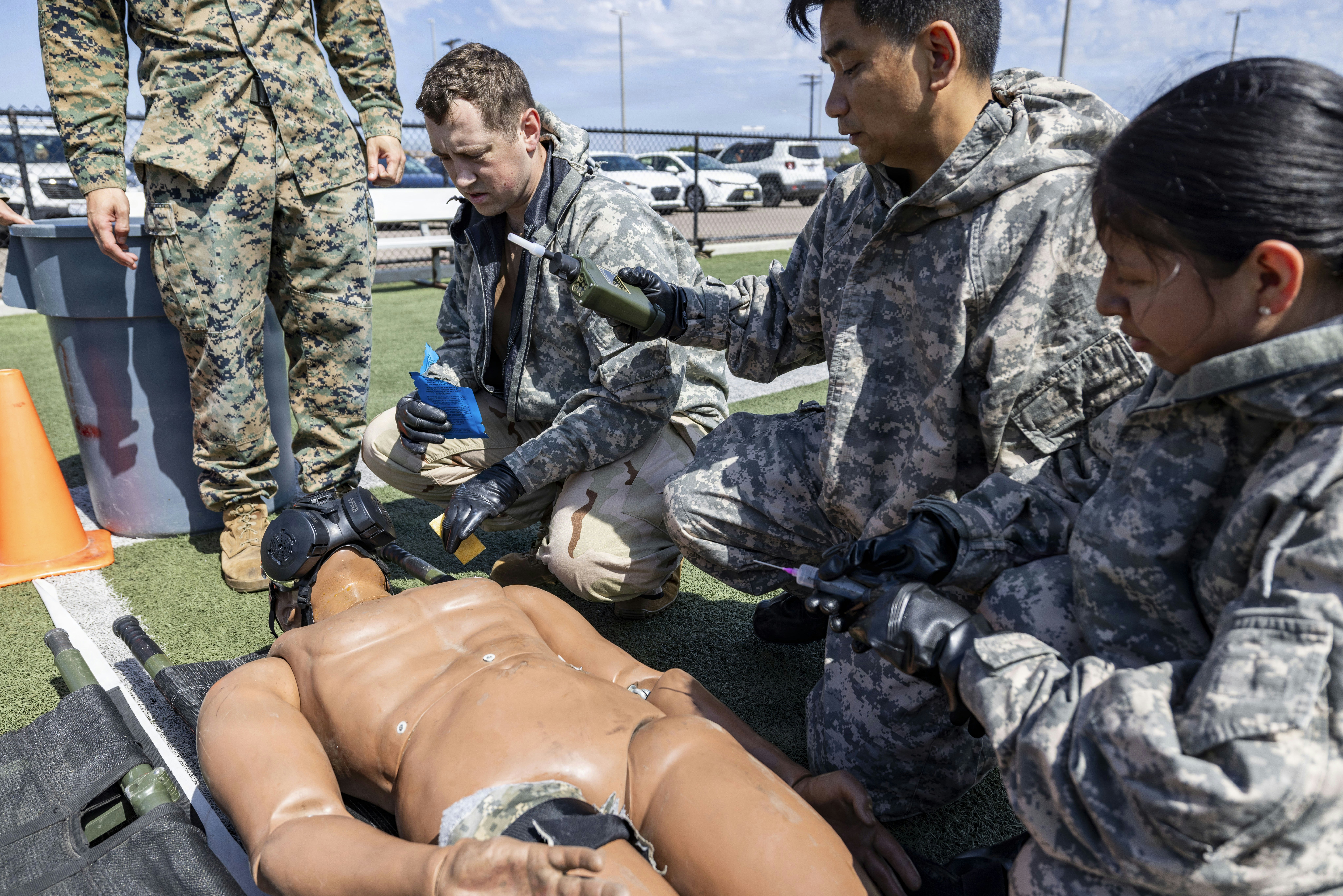 A U.S. Marine with the chemical, biological, radiological, and nuclear platoon, Headquarters and Service Battalion, 1st Marine Logistics Group, evaluates U.S. Navy Sailors assigned to the hospital ship USNS Mercy (T-AH-19) while they triage a simulated casualty during a decontamination demonstration as part of Mercy Exercise 26-3 on Naval Base San Diego, California, June 17, 2026. During MERCEX 26-3, Navy personnel partnered for the first time with U.S. Marines assigned to 1st MLG and 1st Marine Division to execute critical medical and CBRN decontamination training at San Diego naval facilities and aboard the USS Fort Worth (LCS-3). This quarterly exercise directly strengthened readiness and integration between Marines and Sailors to respond safely and effectively in a CBRN environment. (Gunnery Sgt. Jesus Sepulveda Torres)