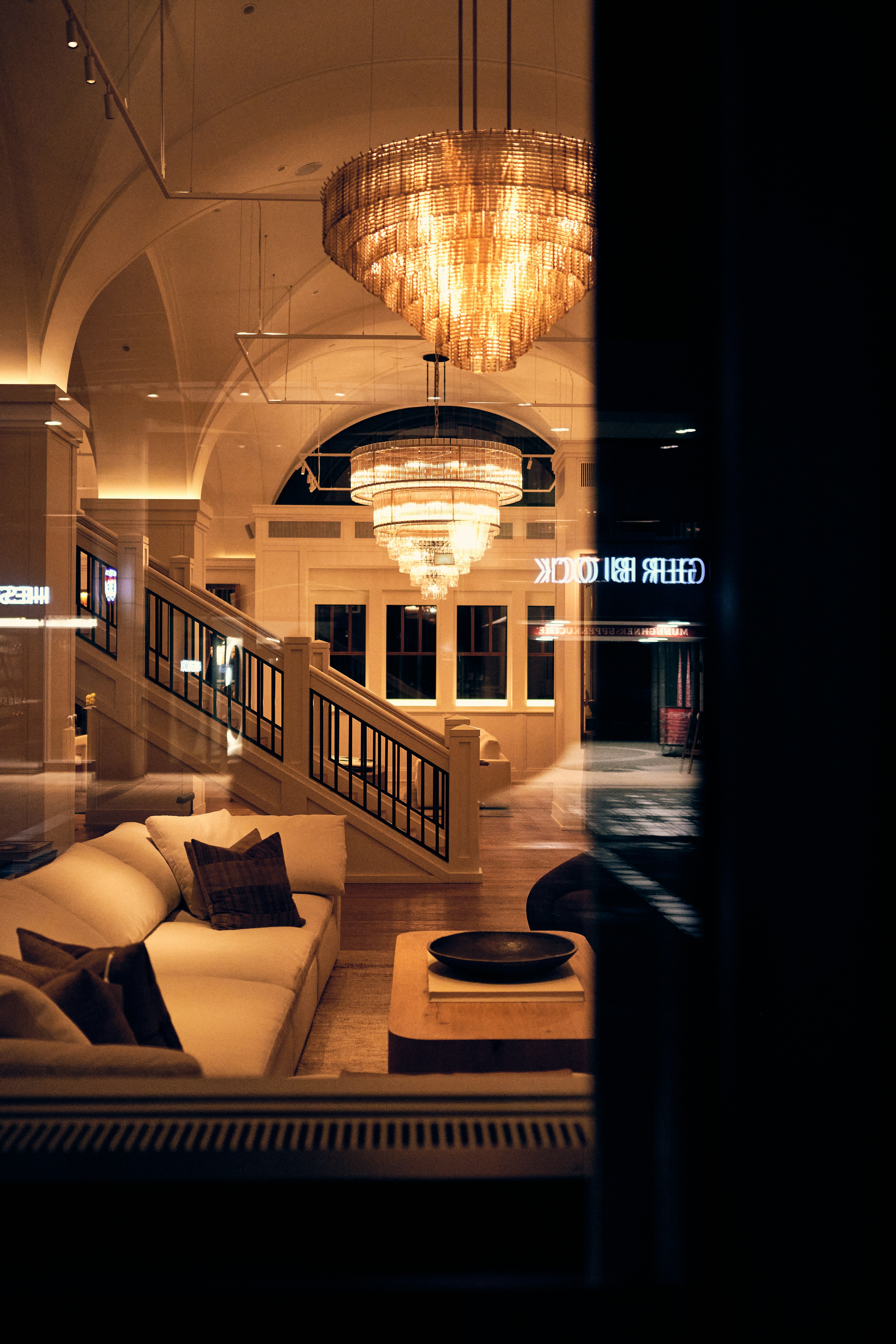 Luxurious Lobby Glow: Warm Chandeliers Reflected in a Quiet Night Scene