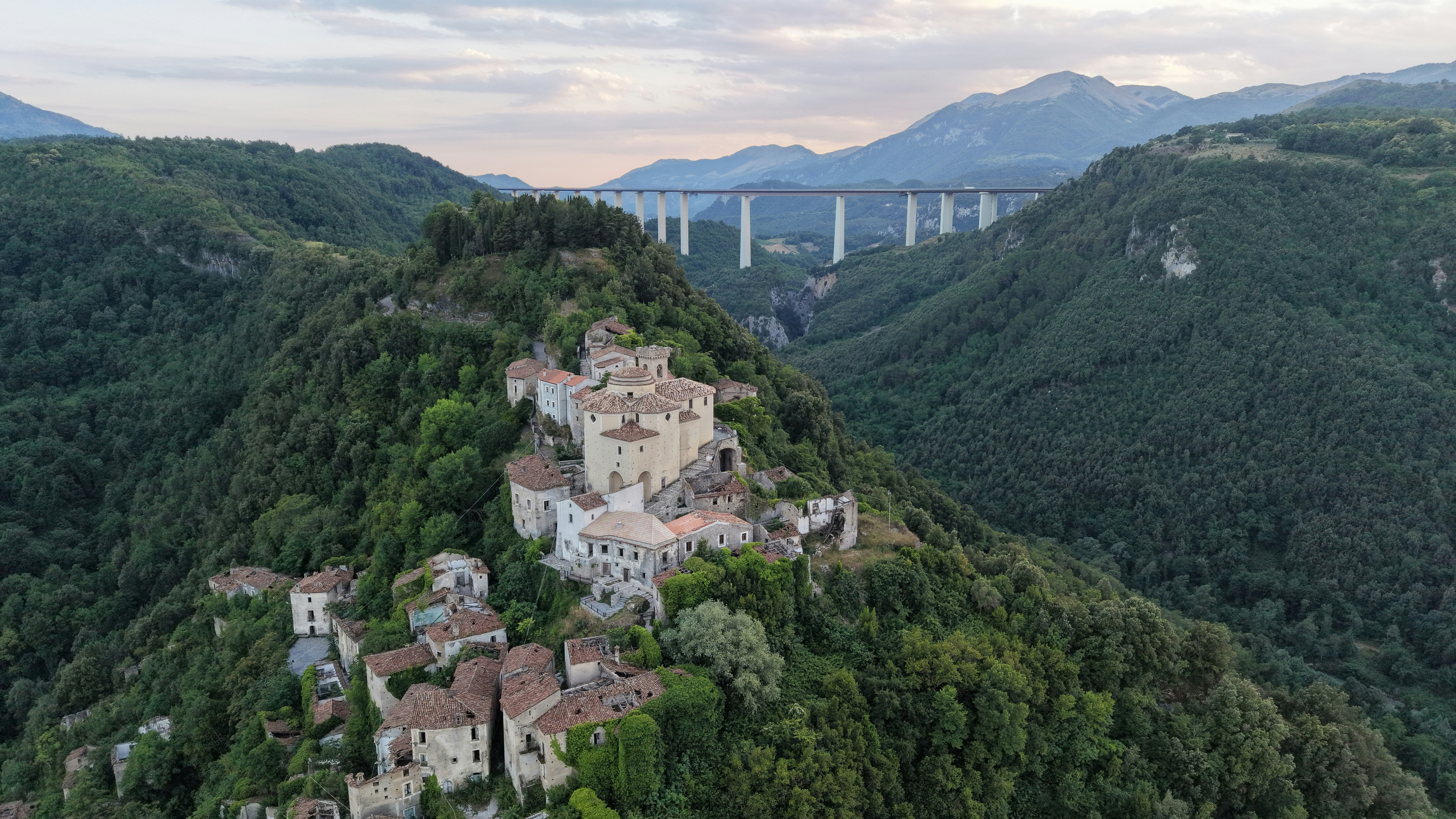 A Cliffside Village Nestled in Verdant Valleys with a Modern Viaduct