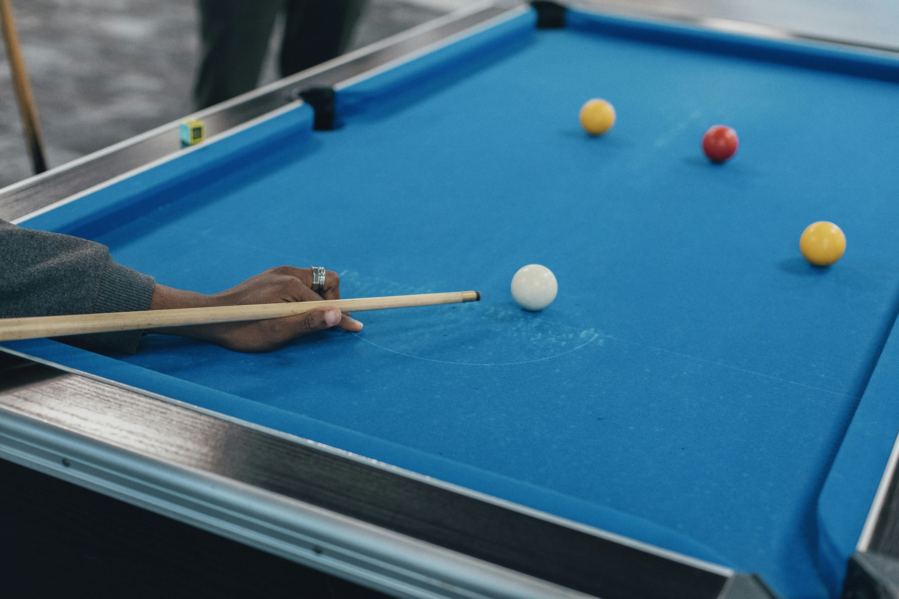 Precision in Blue: The Cue Aligns with a Delicate Break