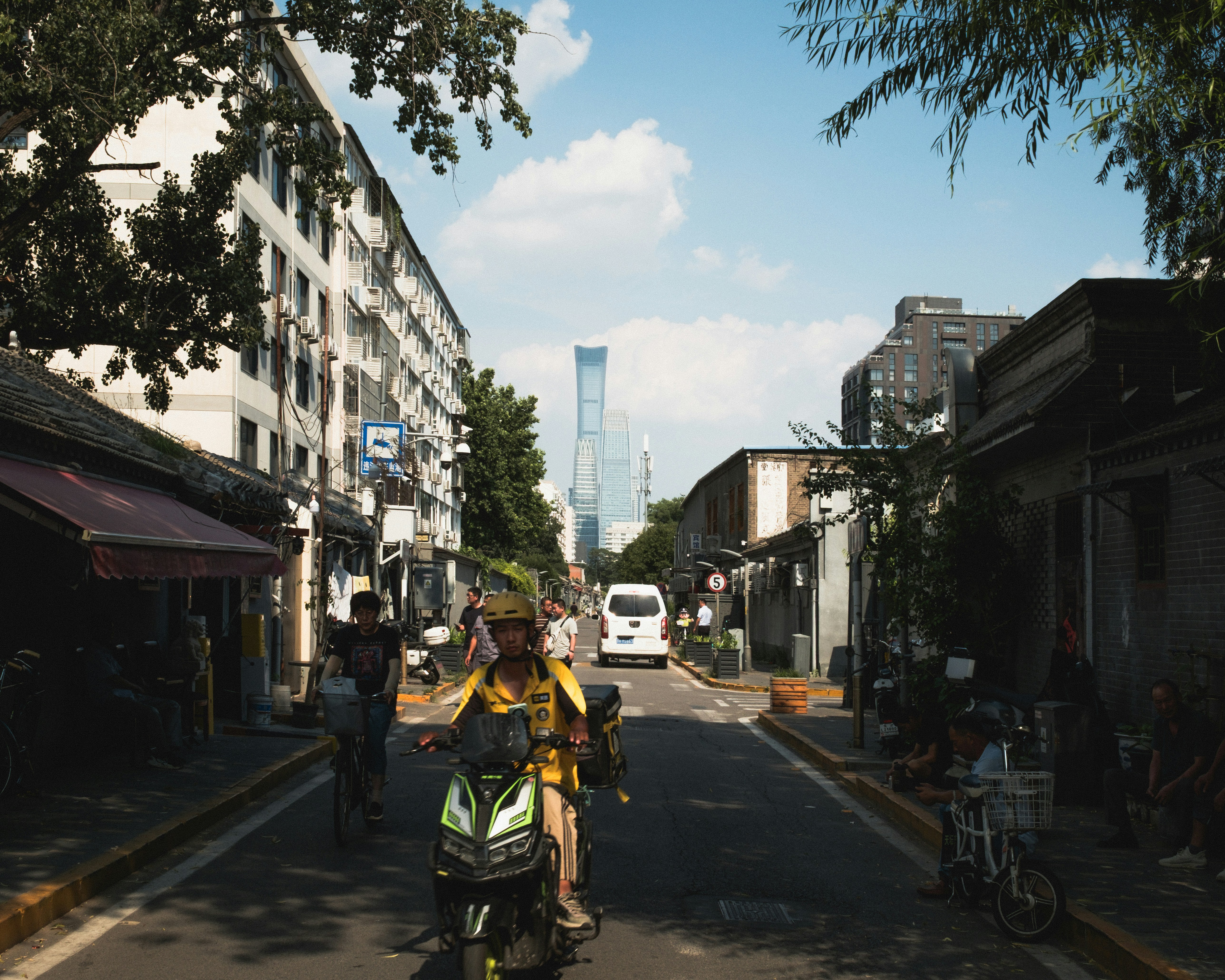 Yellow-vested Rider at a Bustling Urban Street