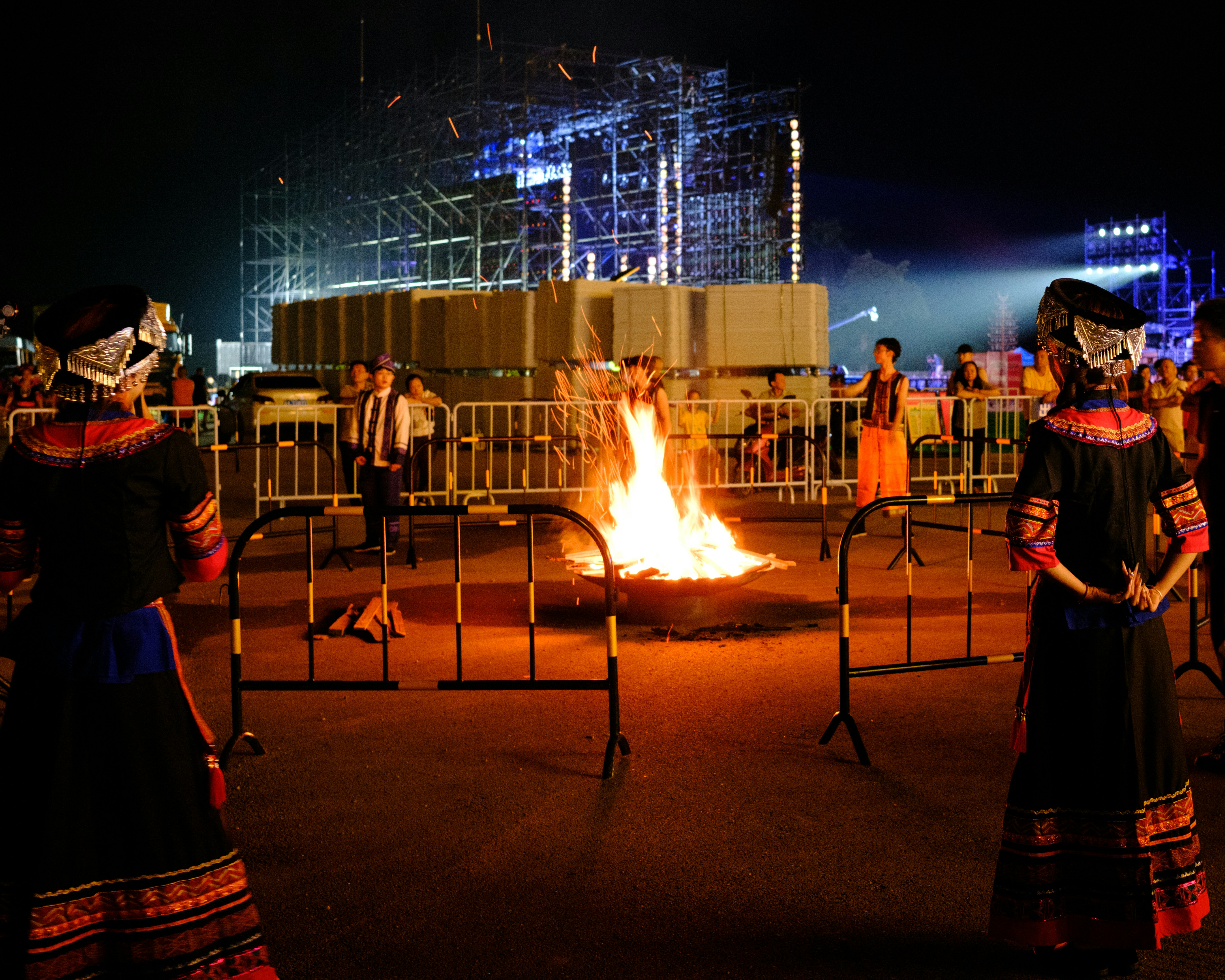 Fiery Circle Beneath a Nightstage of Cultural Attire