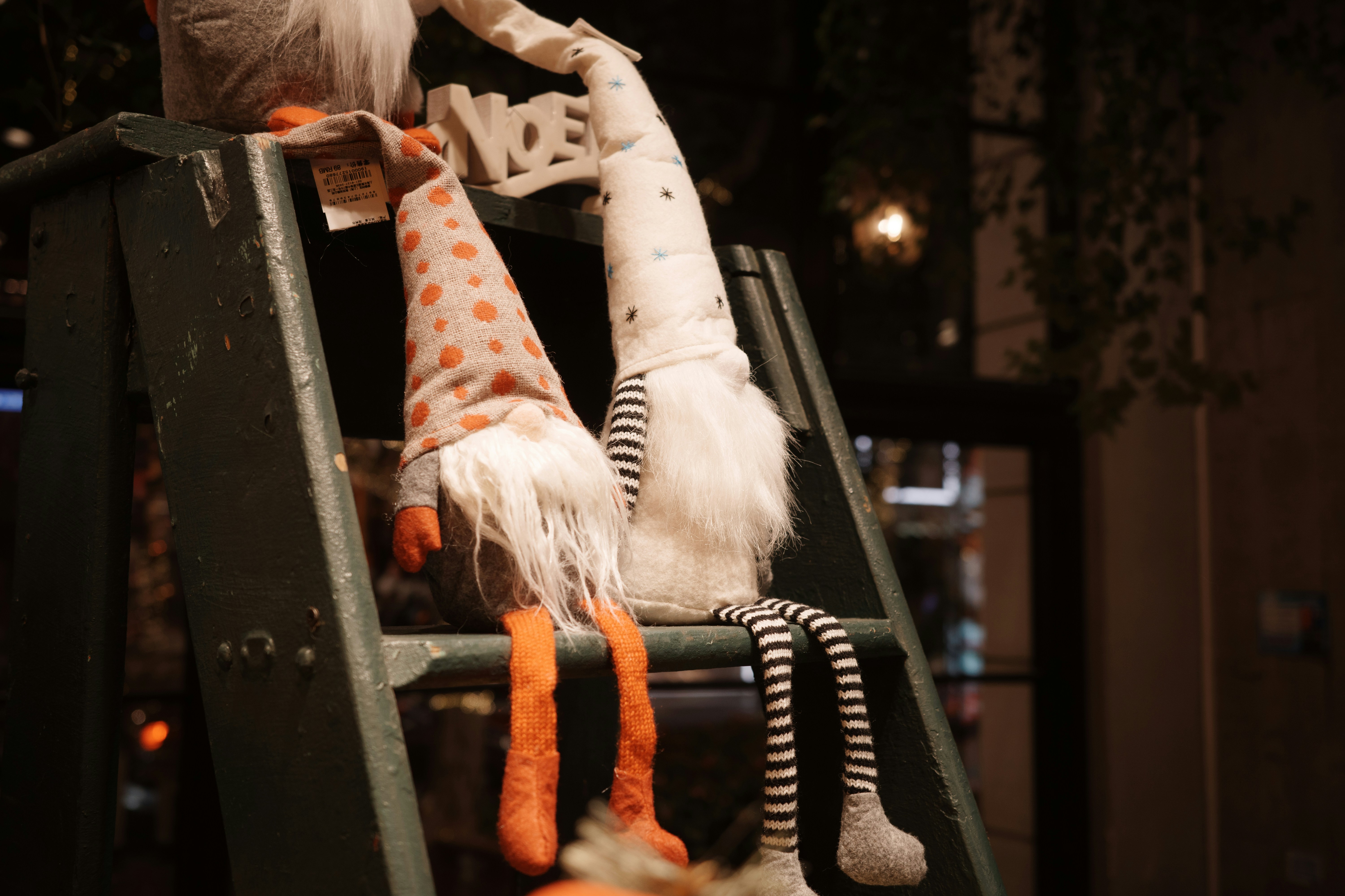 Playful characters on a weathered swing in the dim evening