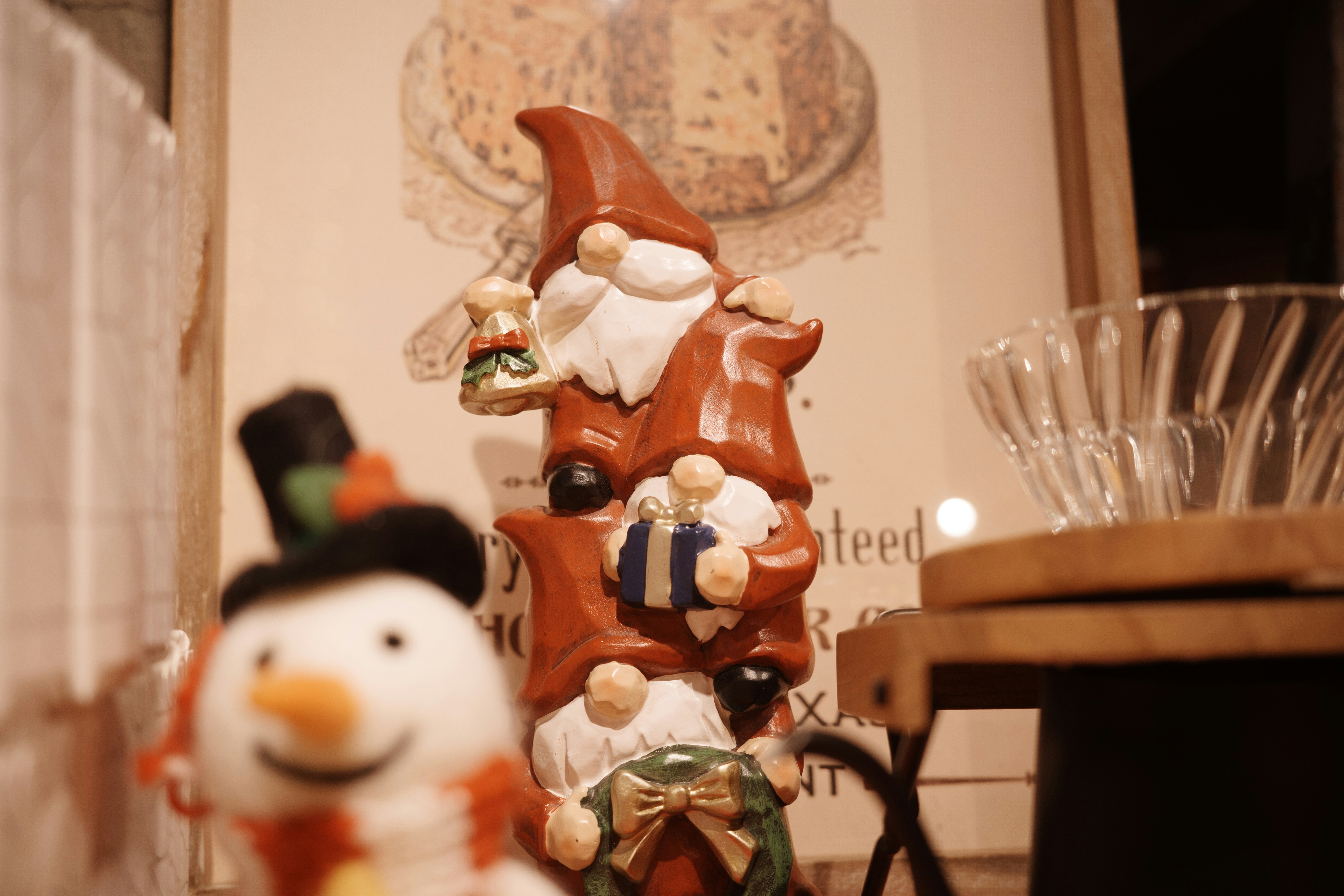 Stacked Santa Figurines Surrounded by Holiday Décor