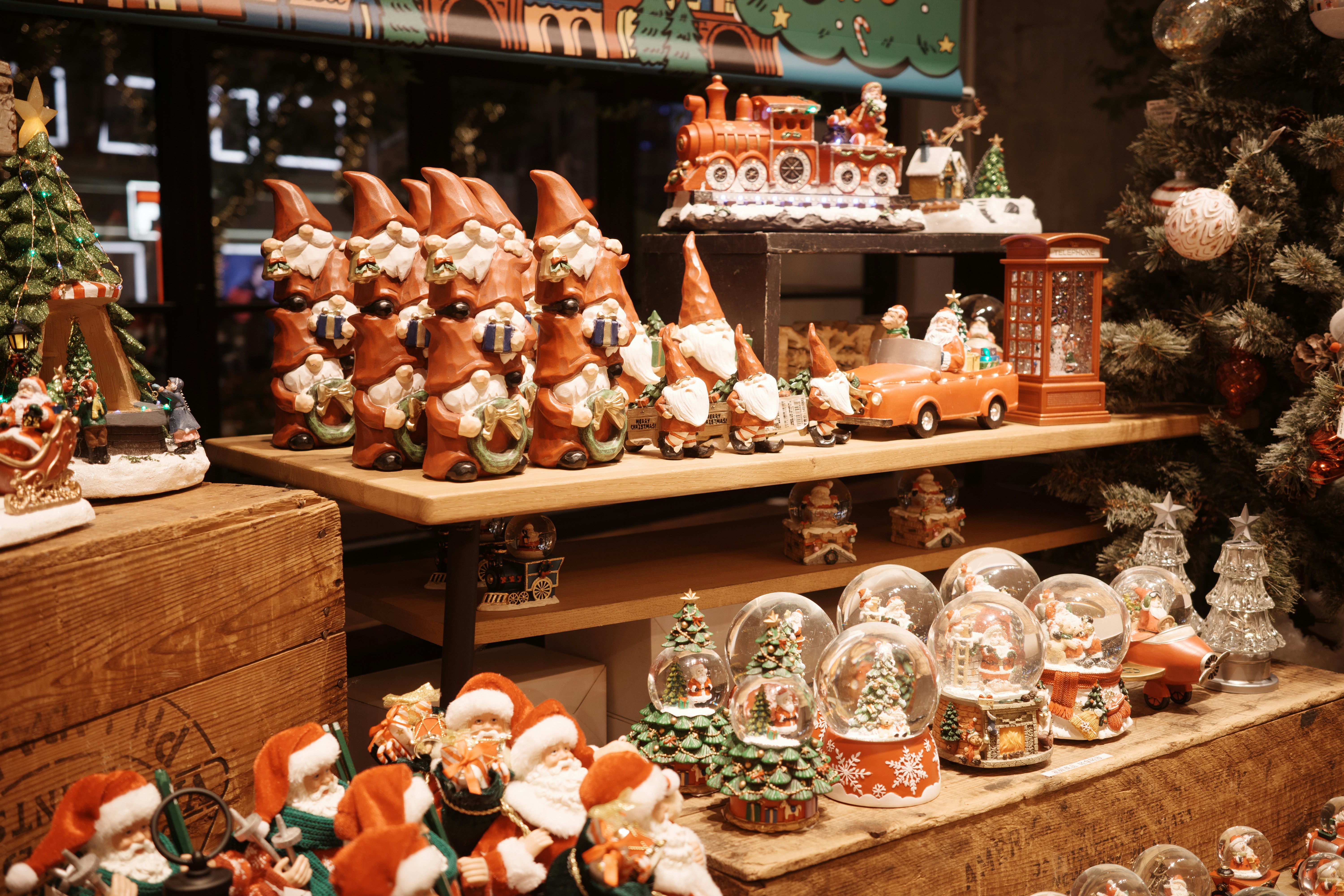Row of Ceramic Gnomes and Snow Globes in a Festive Display