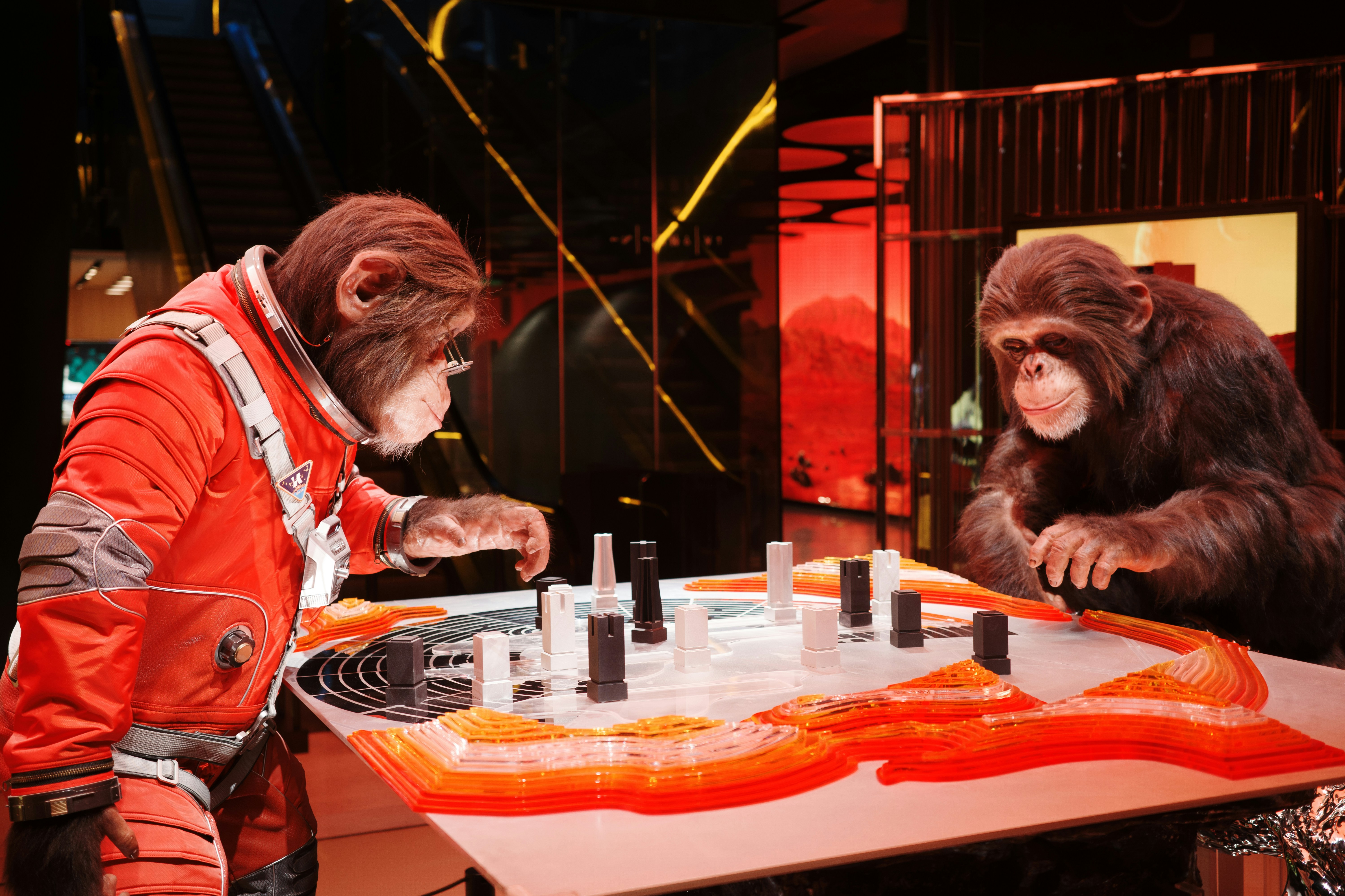 Primates at Play: A Red Suited Scientist and a Curious Chimp Duel a Neon-Outline Puzzle