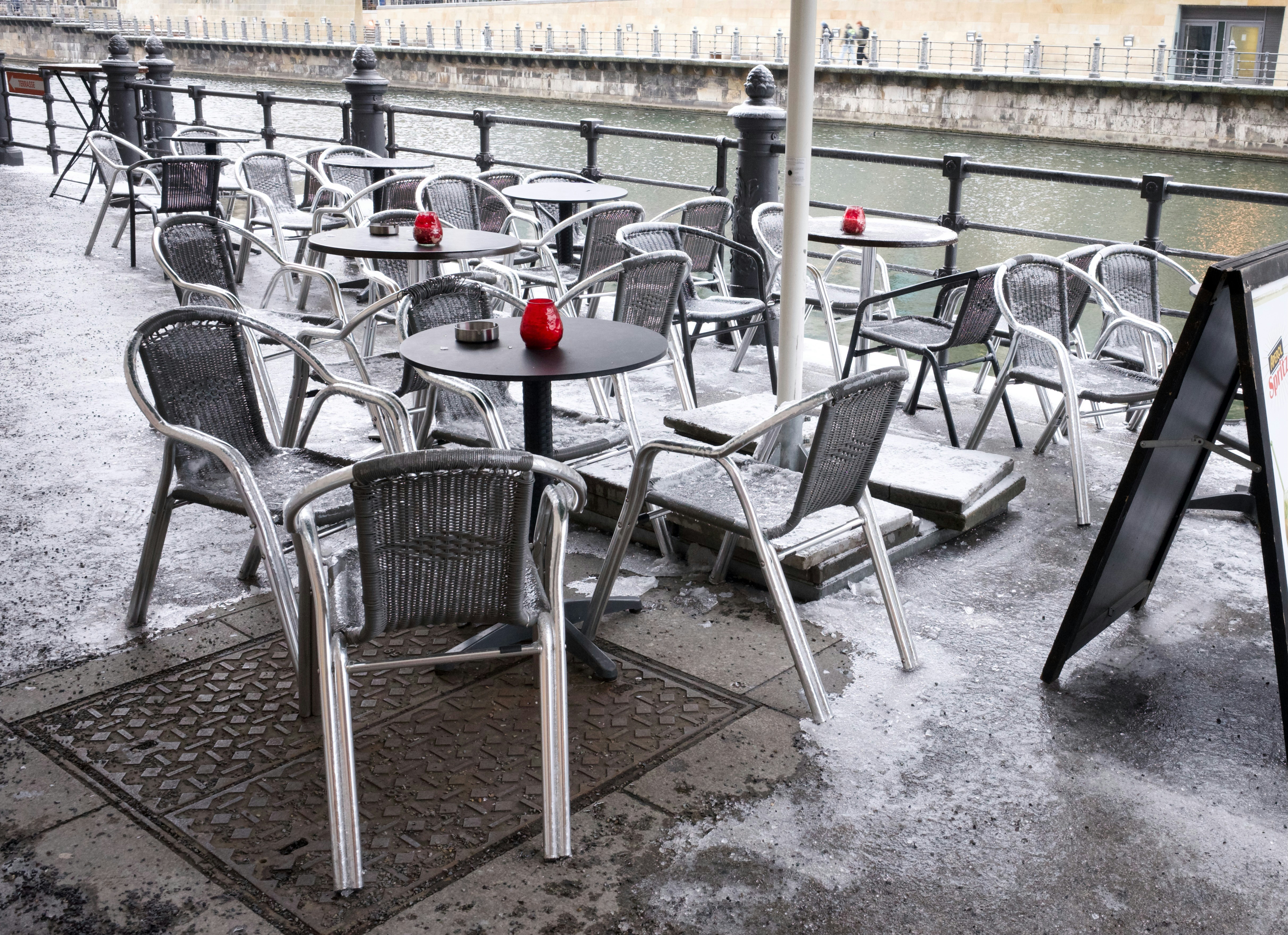 Rain-Kissed Terrace: Quiet Tables by the River
