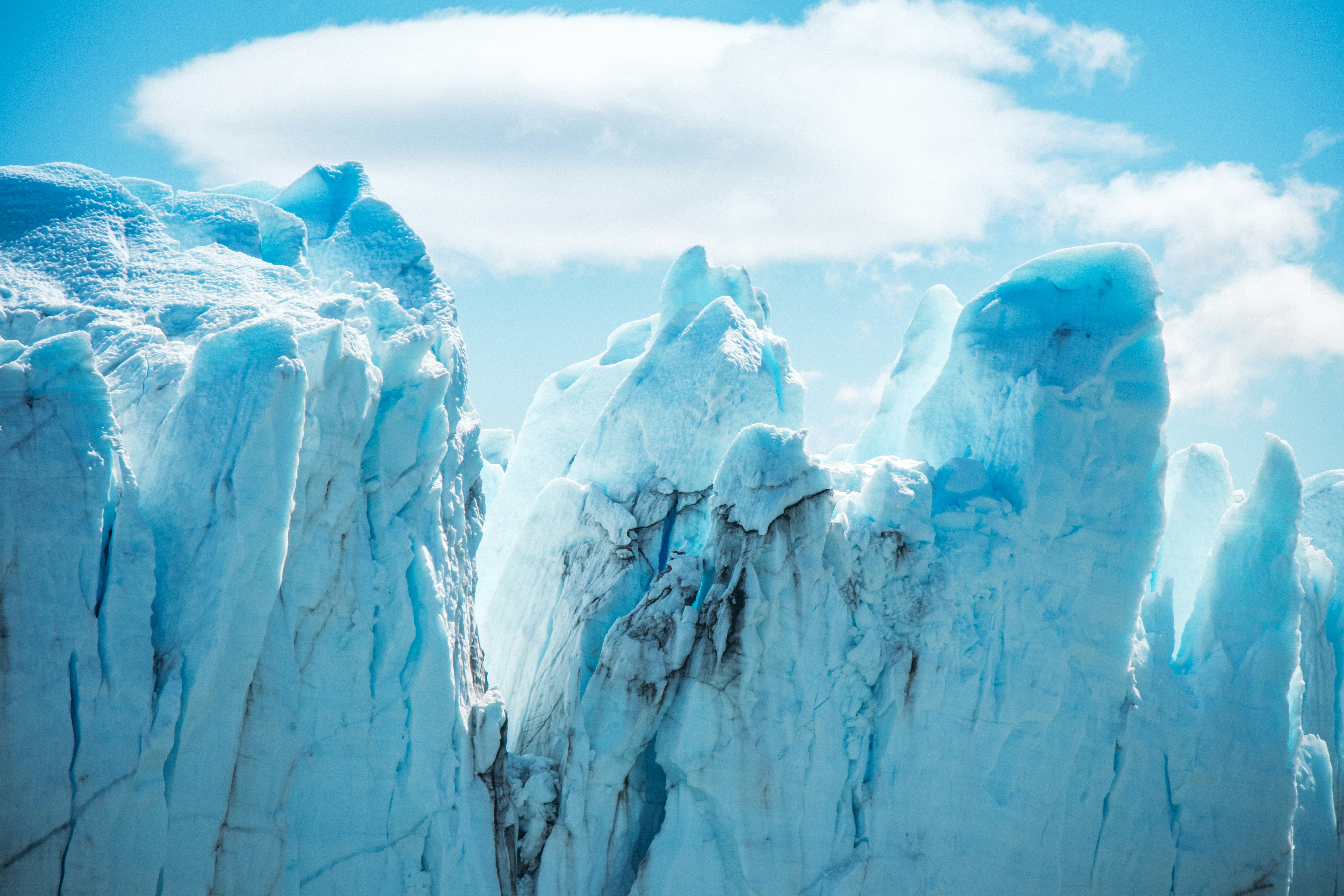 Glacial Sentinels: Blue Crevasses Reaching for the Sky