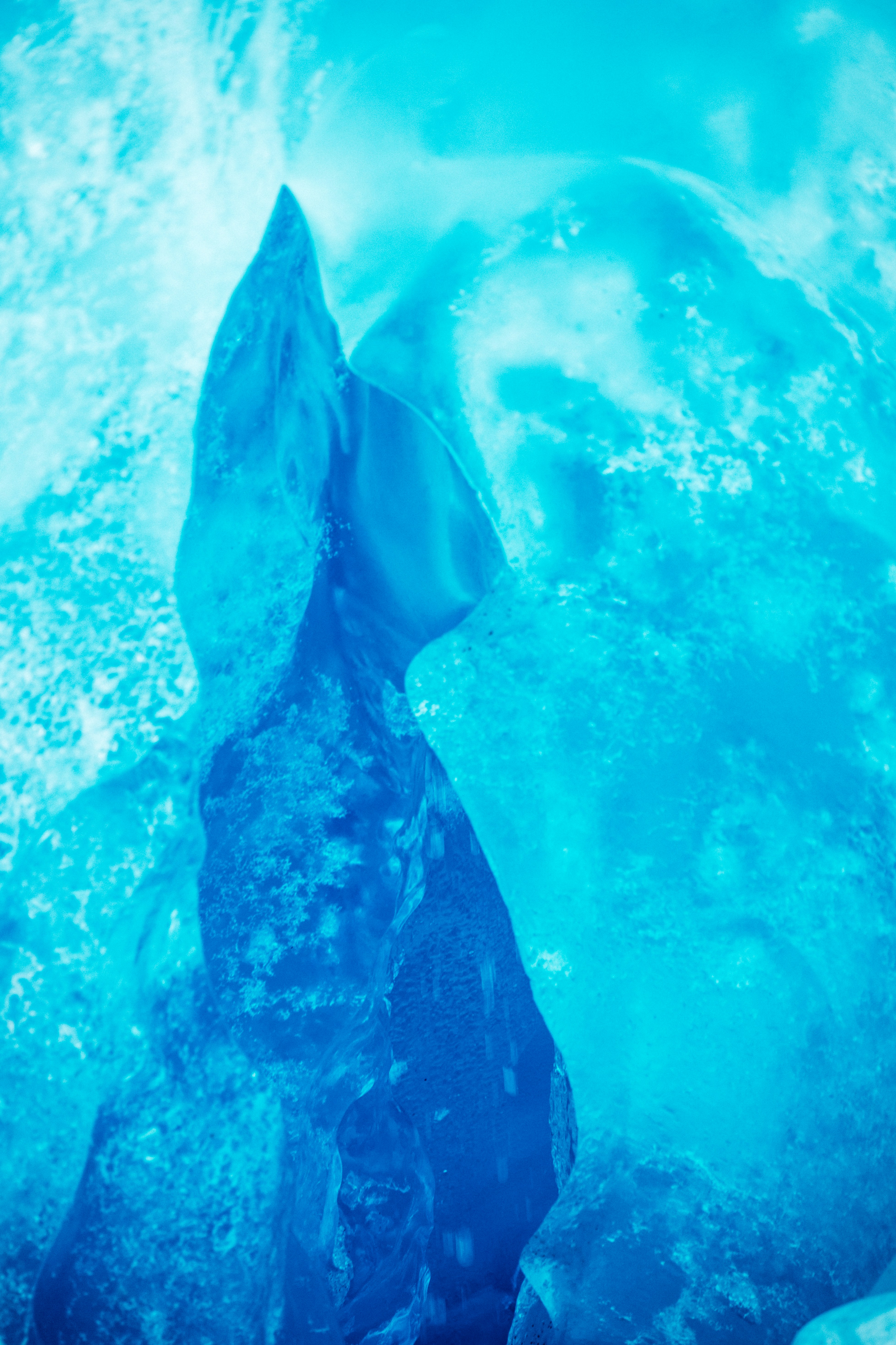 Glacial Prism: A Shard of Ice Rising Through Oceanic Turquoise