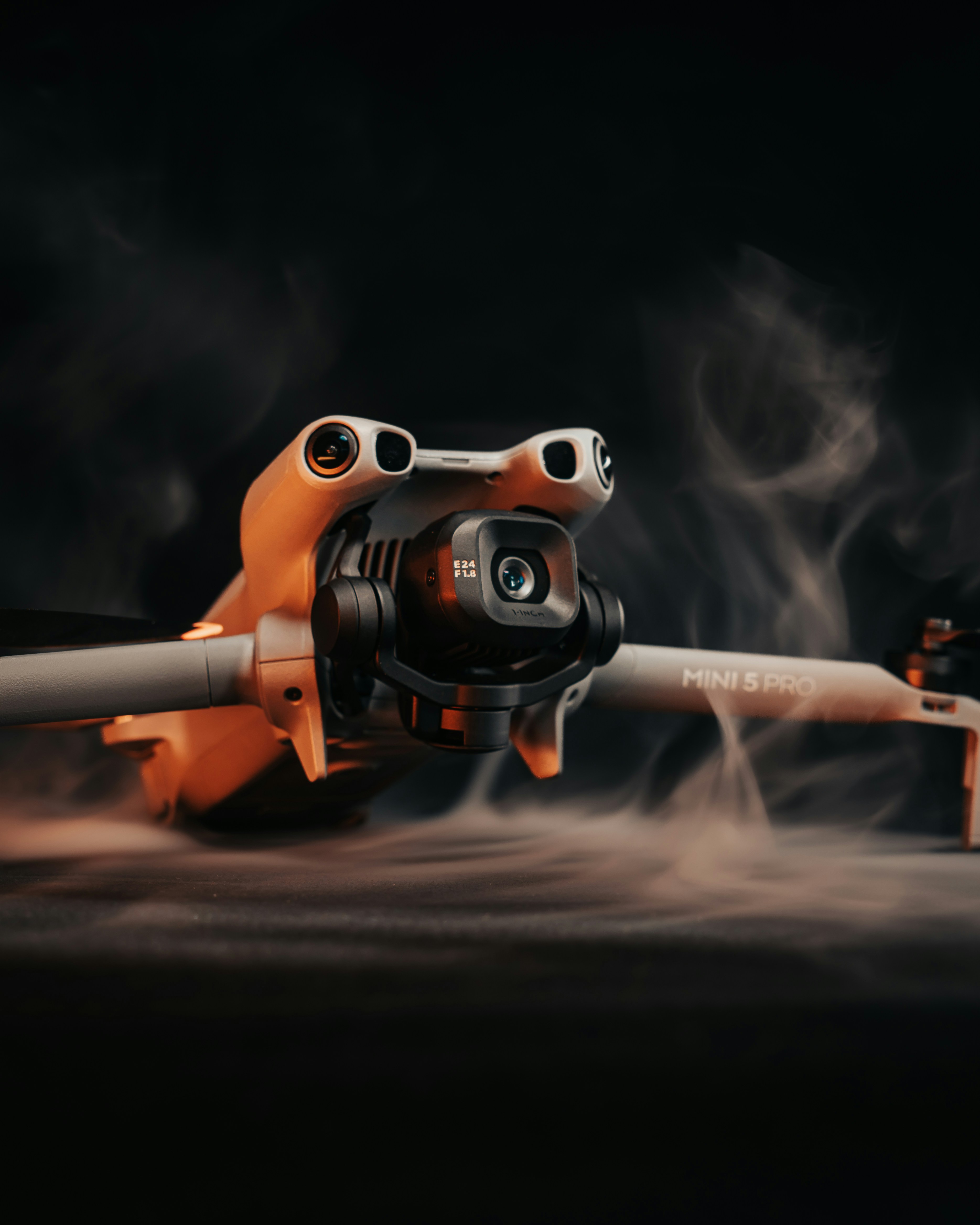 Close-up of a drone gimbal ready for takeoff, bathed in moody smoke