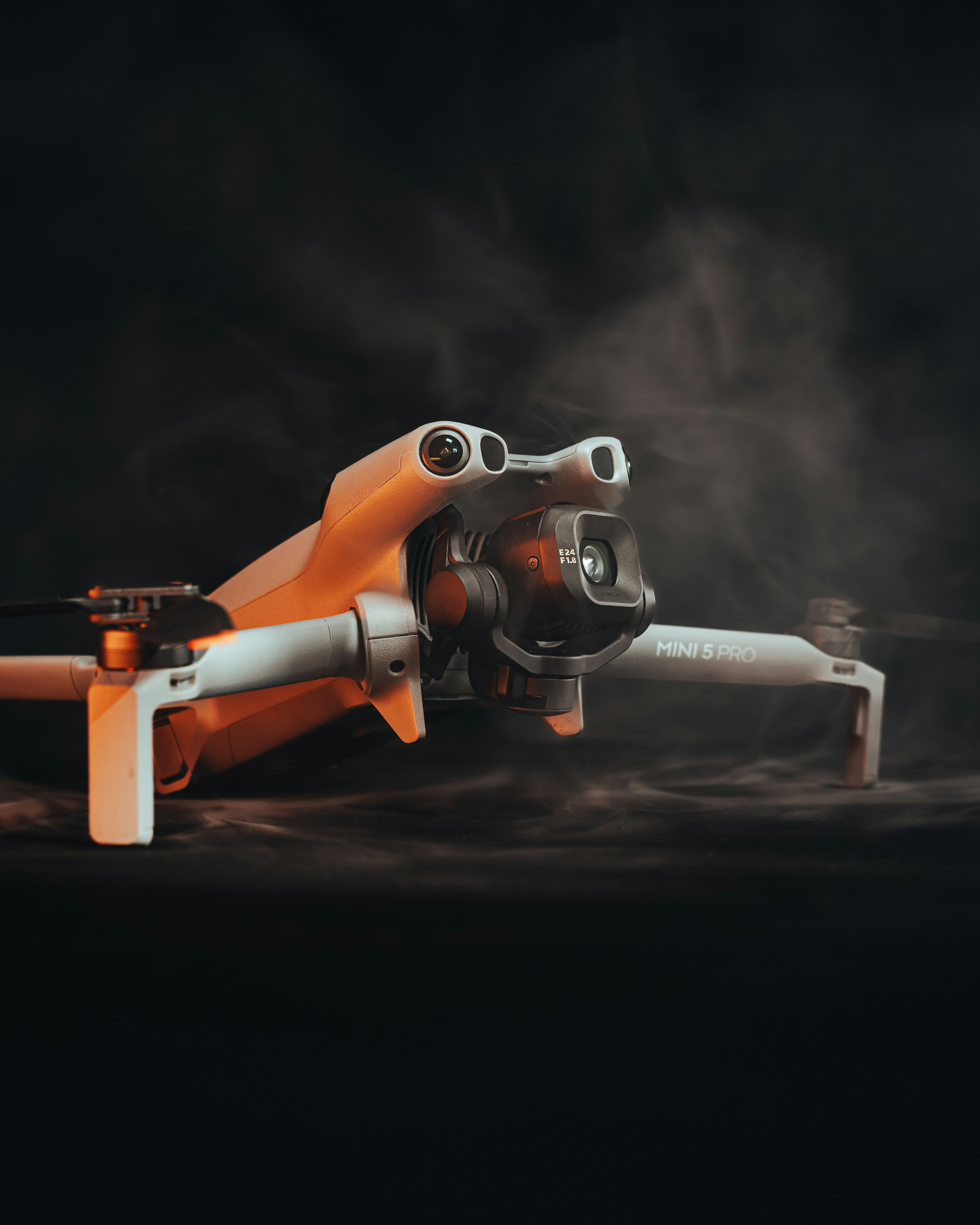 Orange Quadcopter in Low-Light Spotlight
