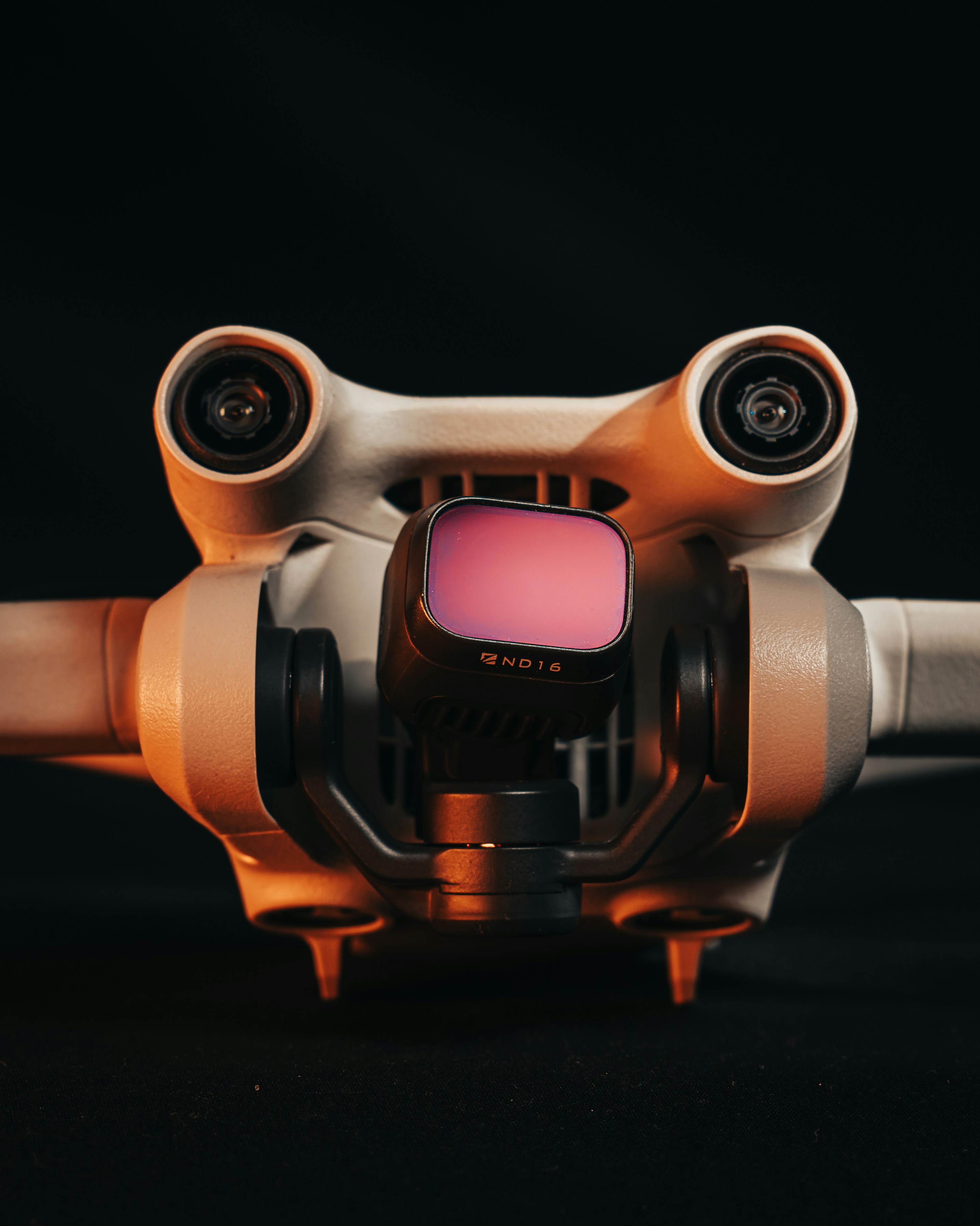 Close-Up of a Drone Gimbal: Centered Lens Housing and Pink Filter