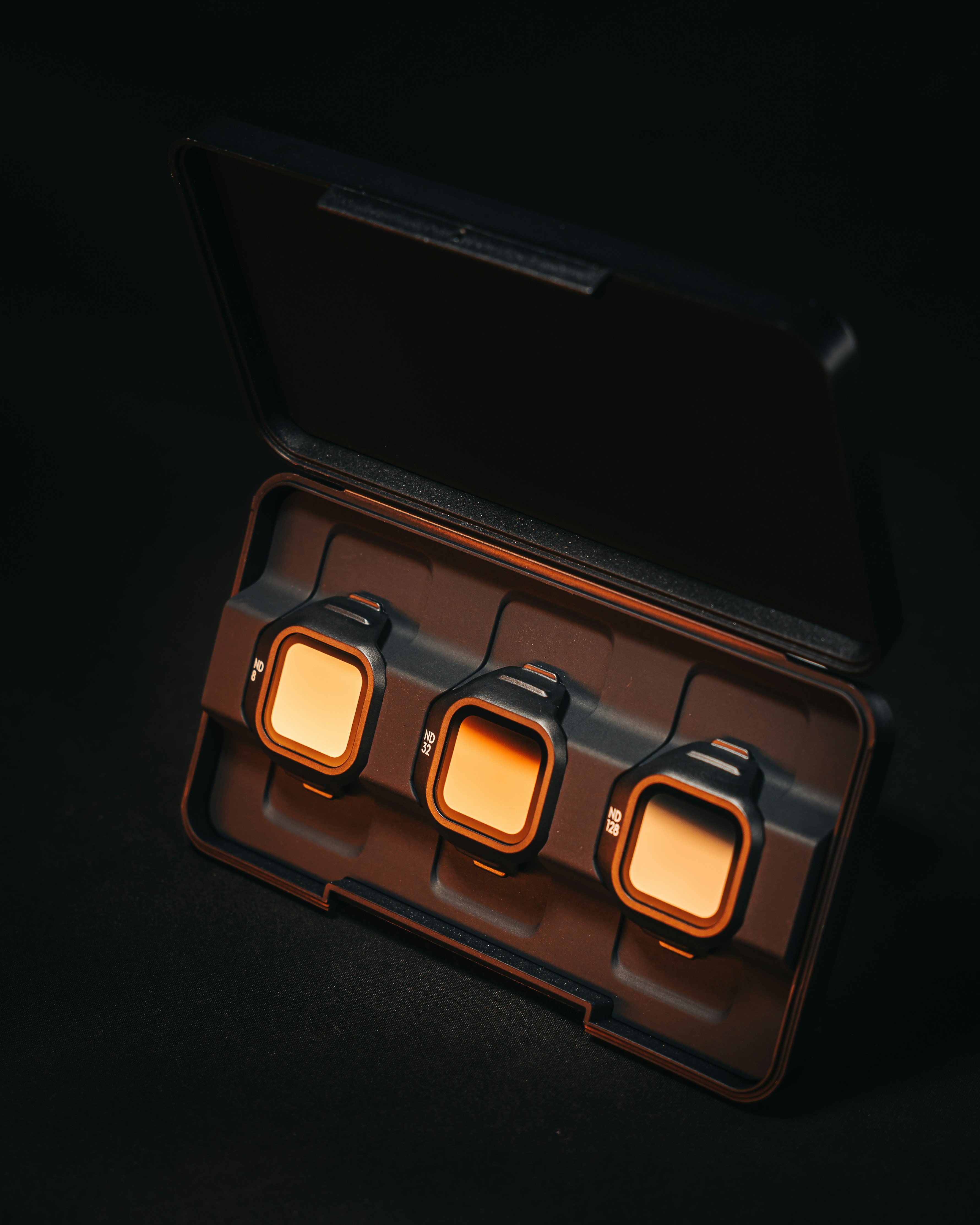 Three Tiny Lenses in a Protective Shell: A Close-Up of a Matte Orange Trio