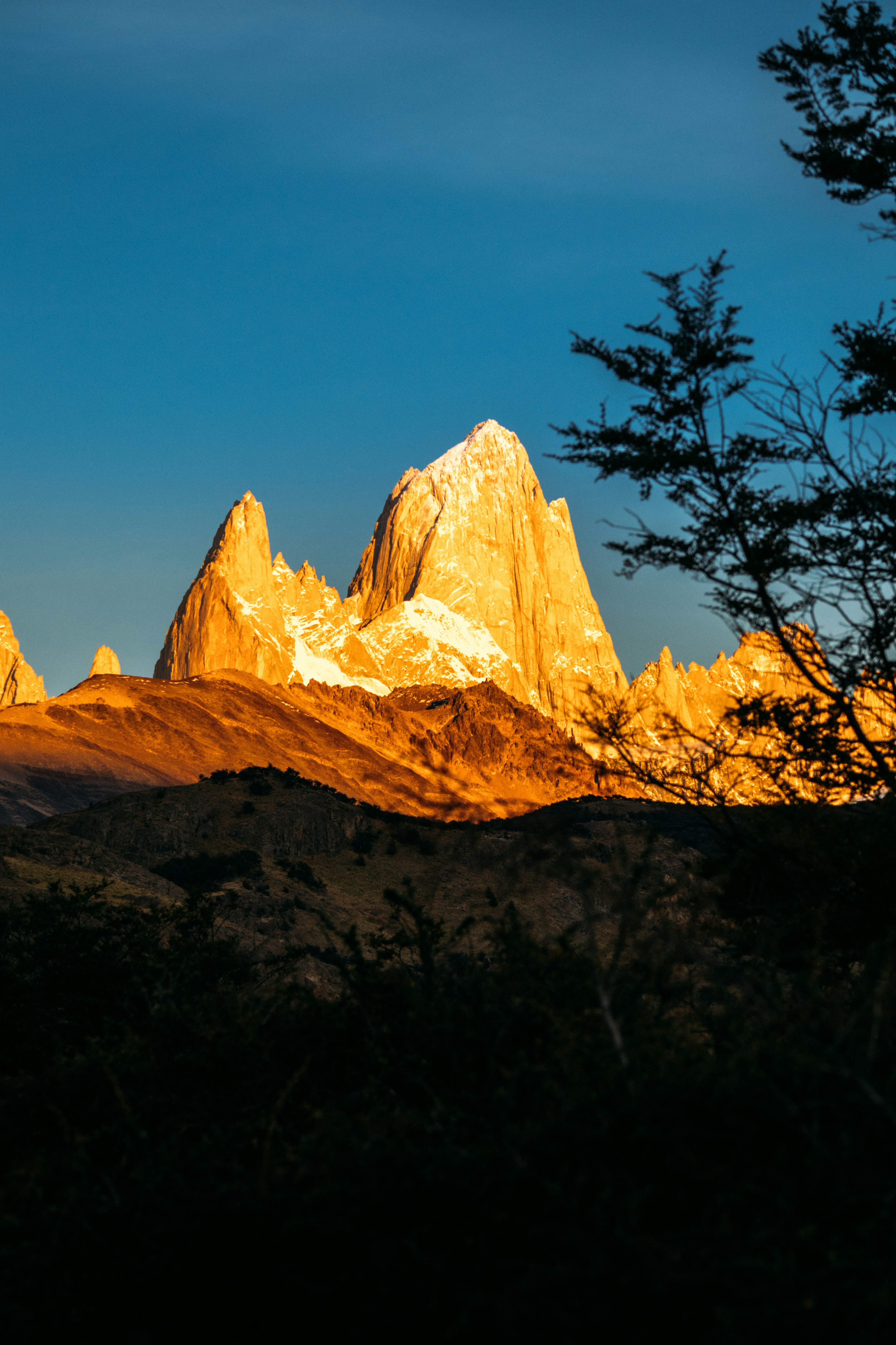 Golden Peak at Dusk: Sunlit Summit Behind Dark Foreground