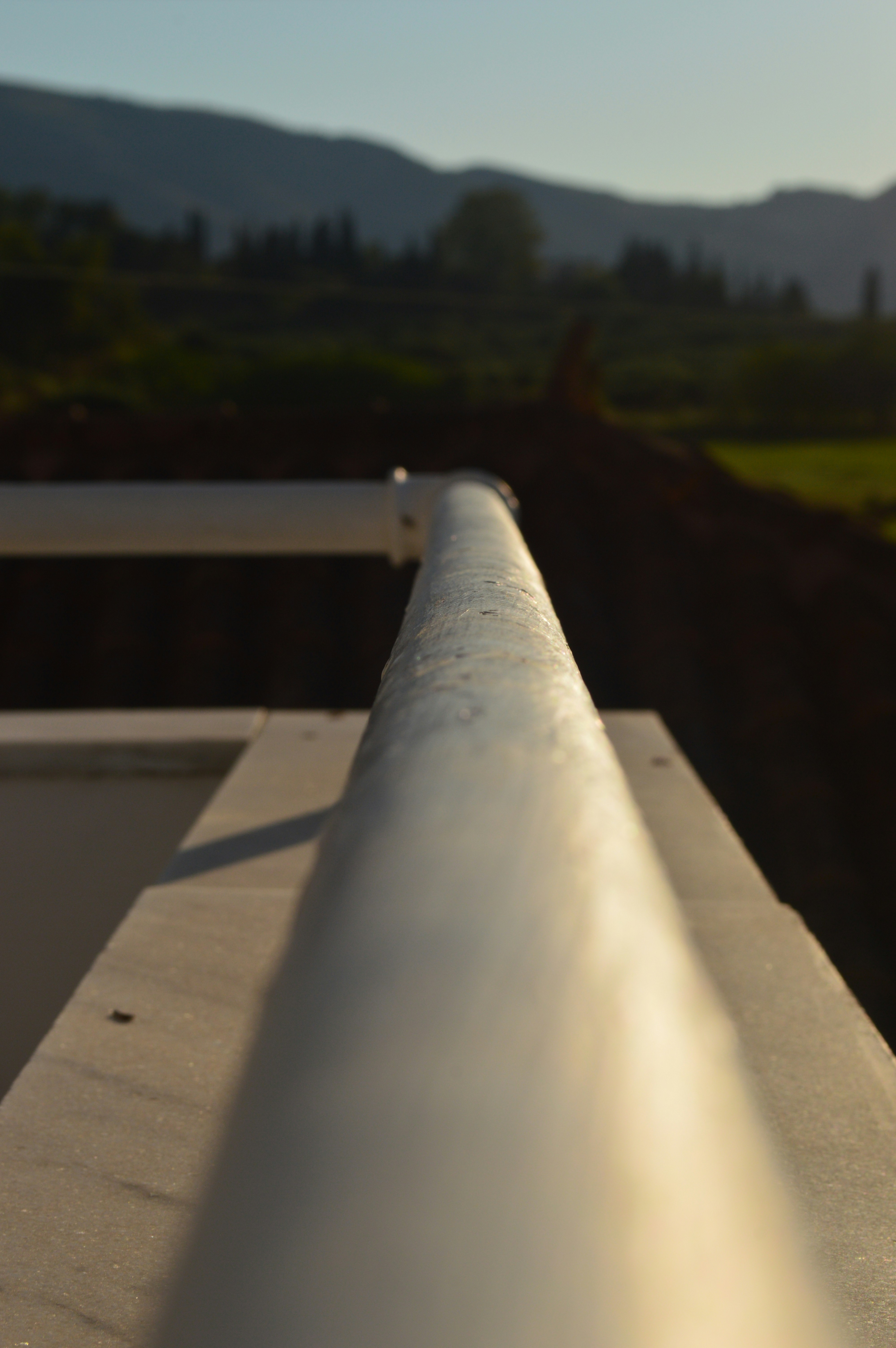 Ridge Rail in Soft Focus: A Close-Up on the Handrail Leading to Distant Hills