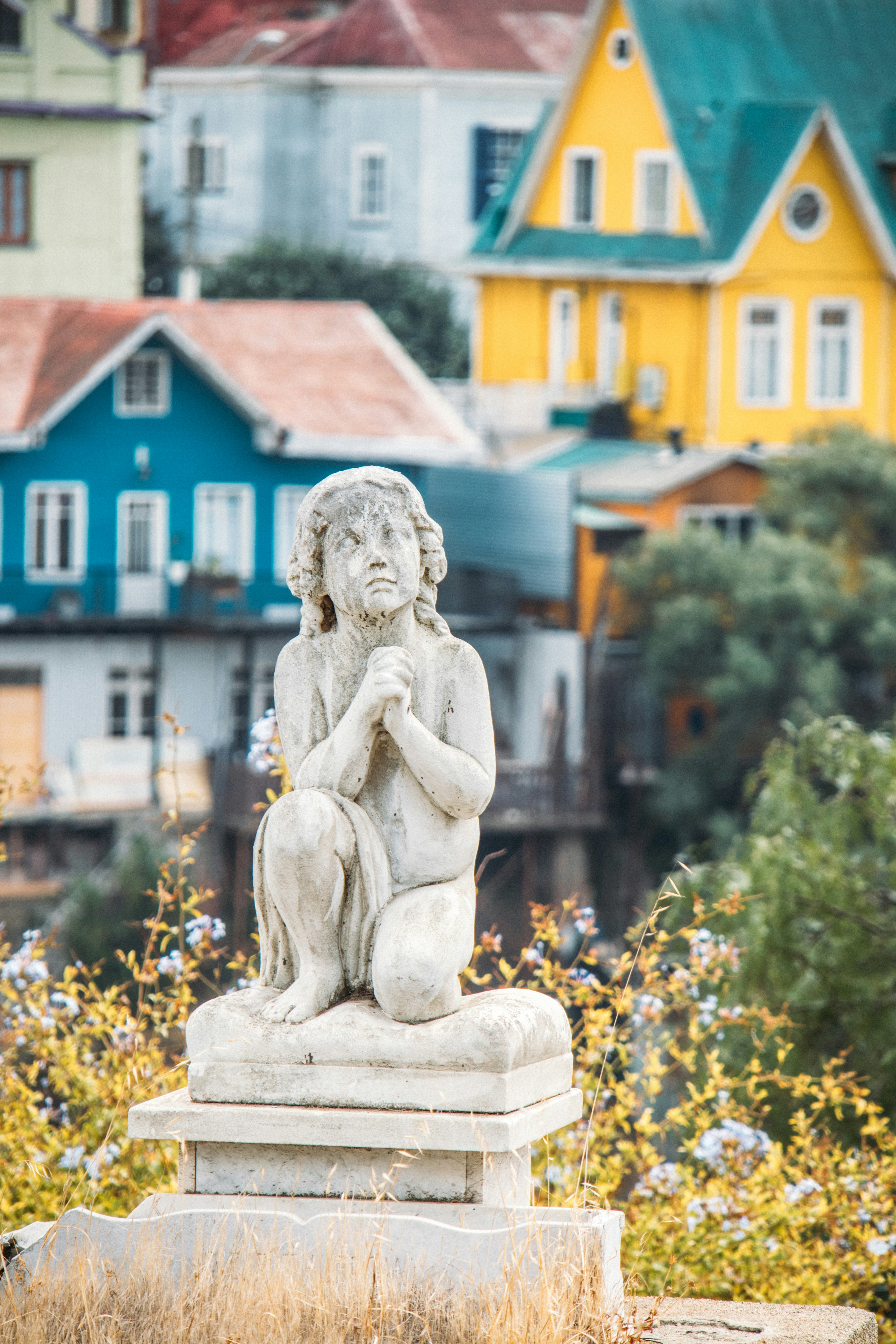 Contemplative Stone Guardian at Colorful Coastal Village