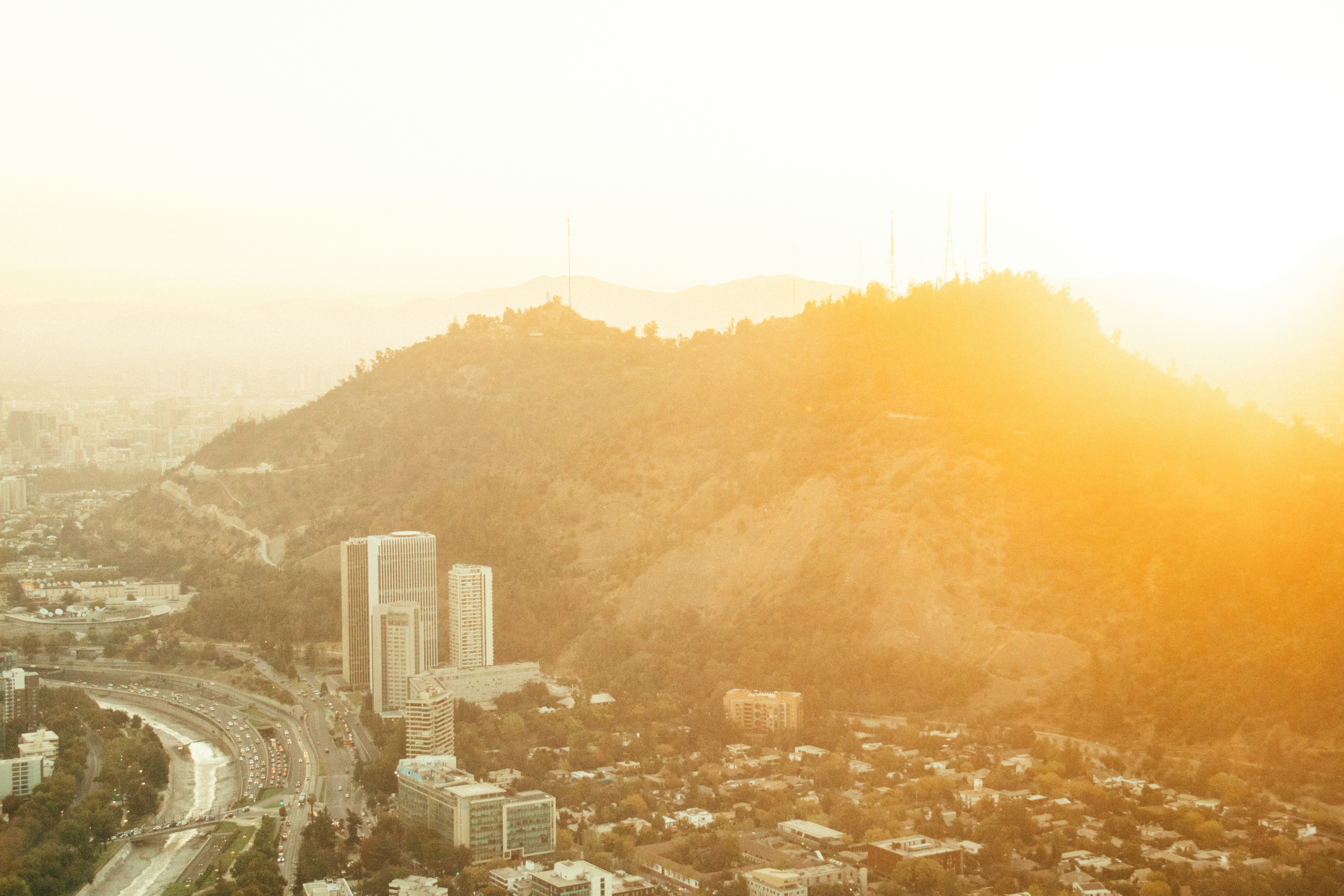 Sunlit Hills Over a City: A Glowing Horizon at Golden Hour