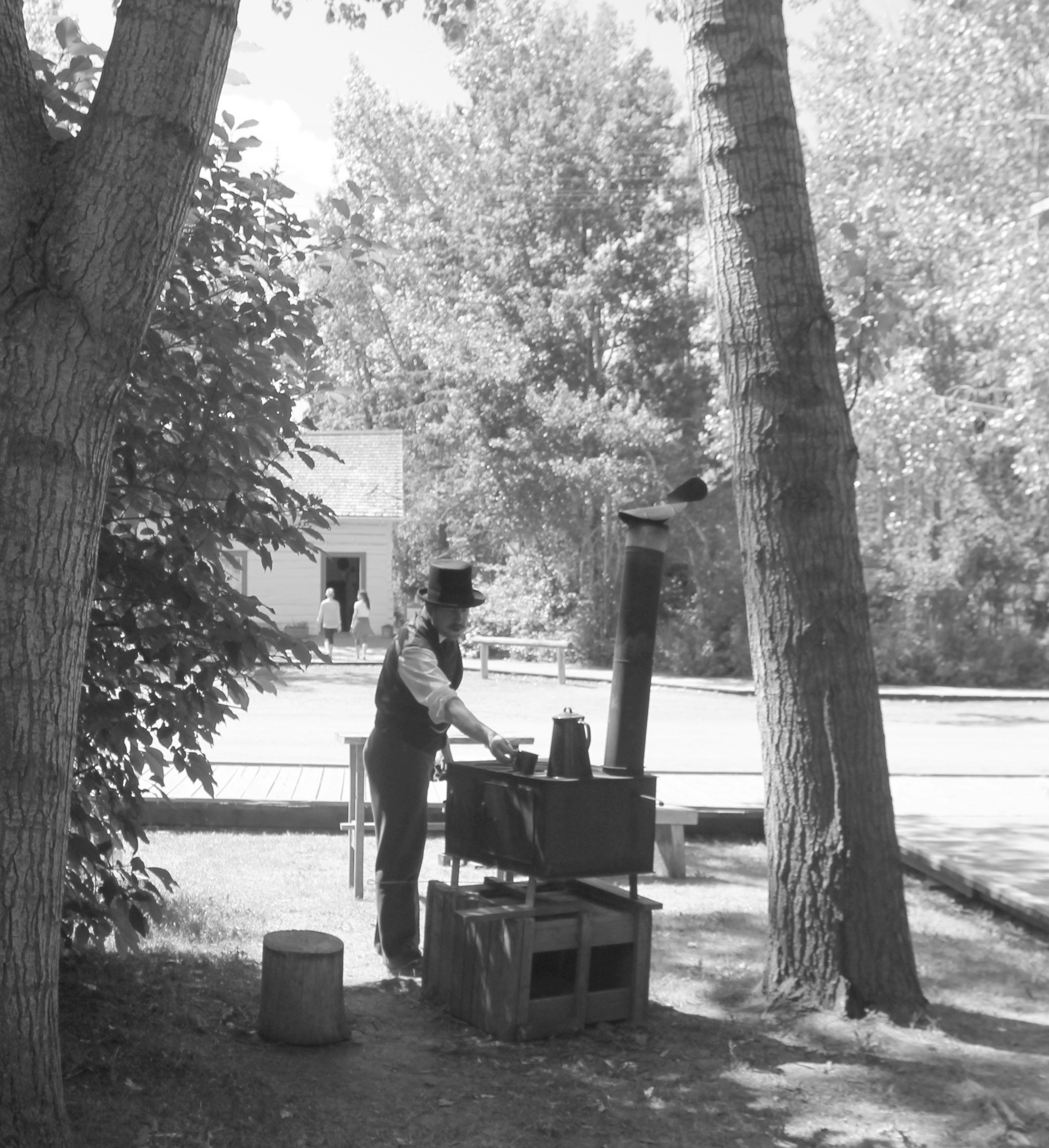 Street Vendor with Coffee Kettle and Stove Under the Shade of Trees