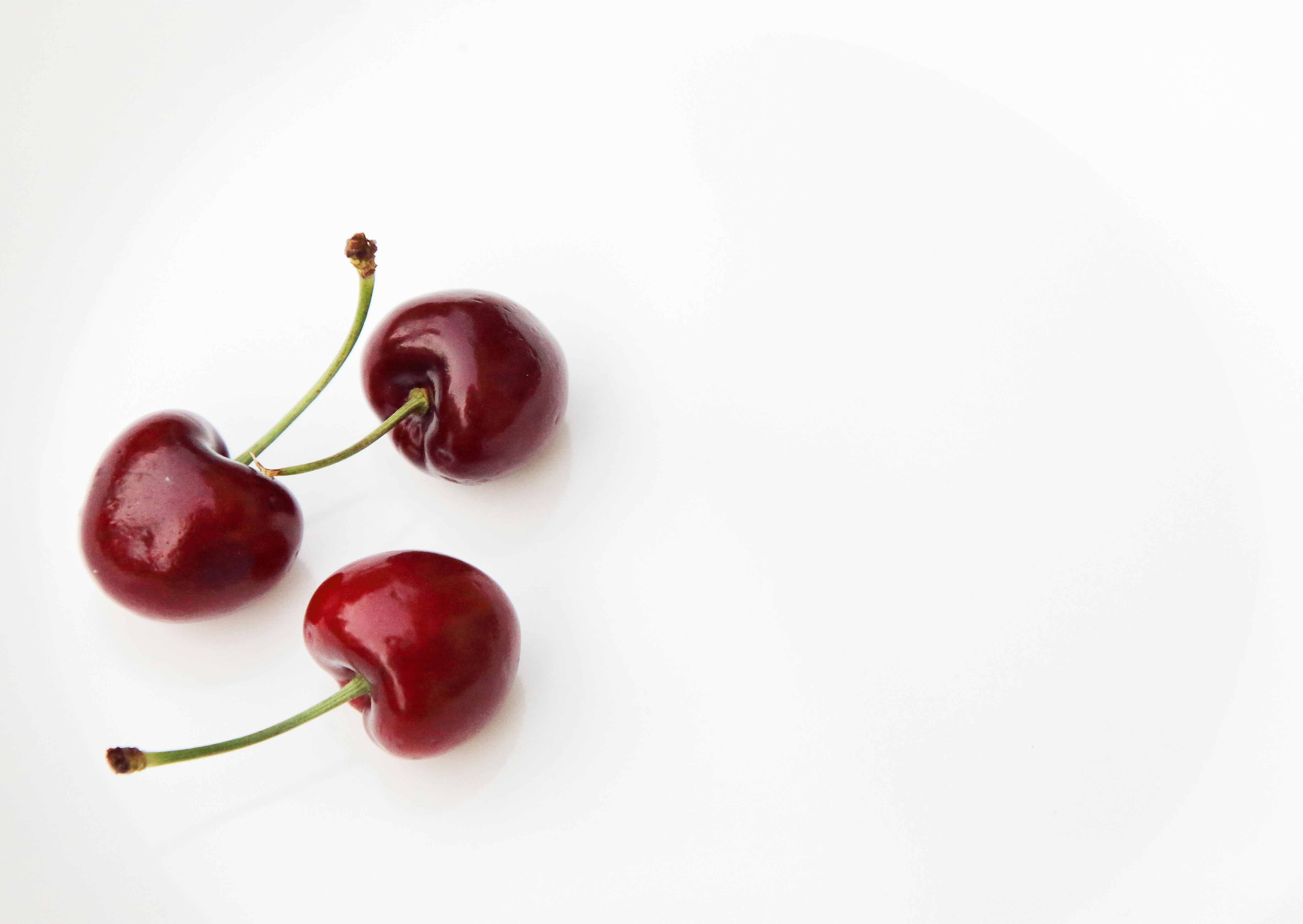 Three Cherries on White Canvas