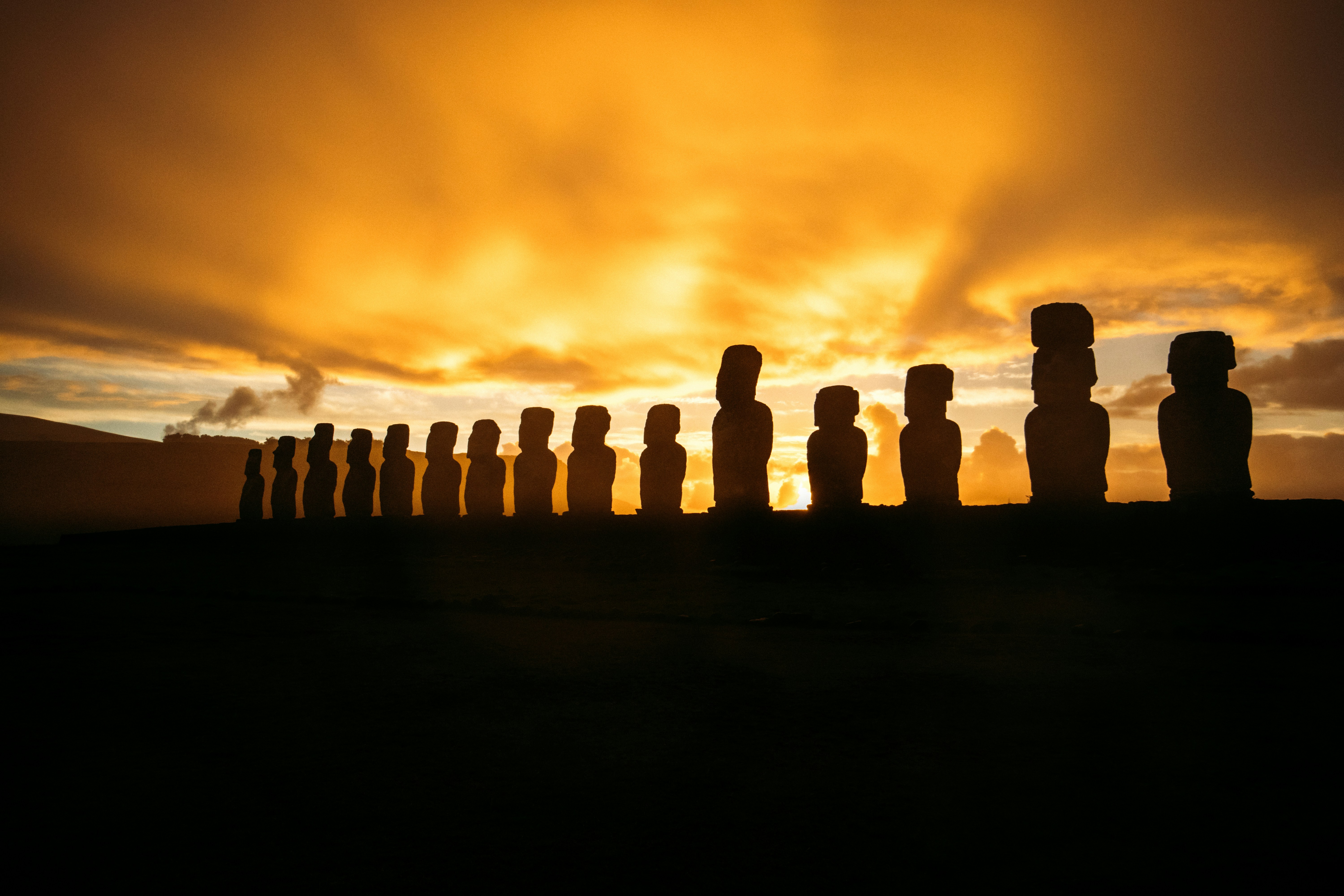Sunset Giants: Stone Statues Align the Distant Ridge