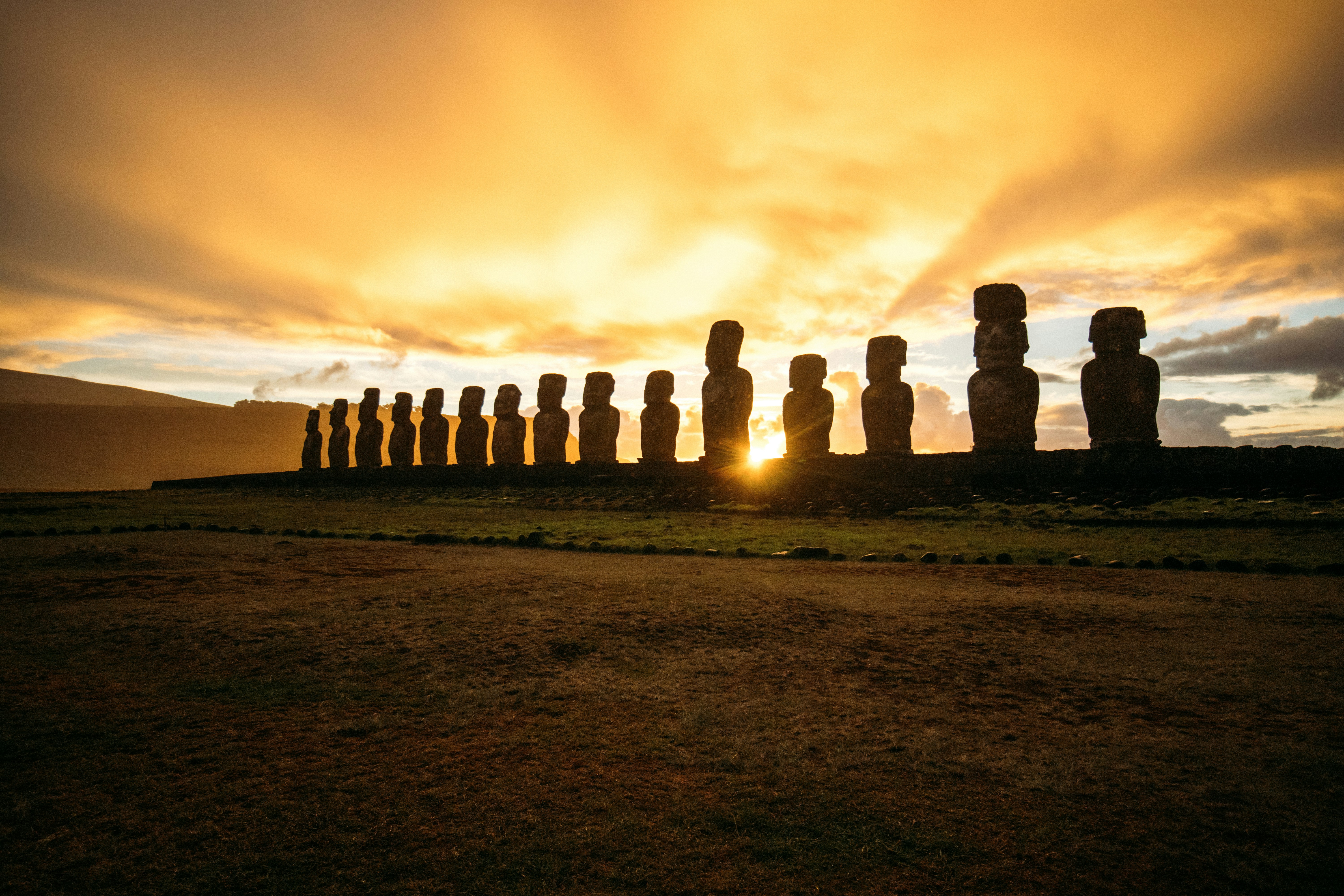 Sunlit Moai Line: Dawn Over the Island Horizon