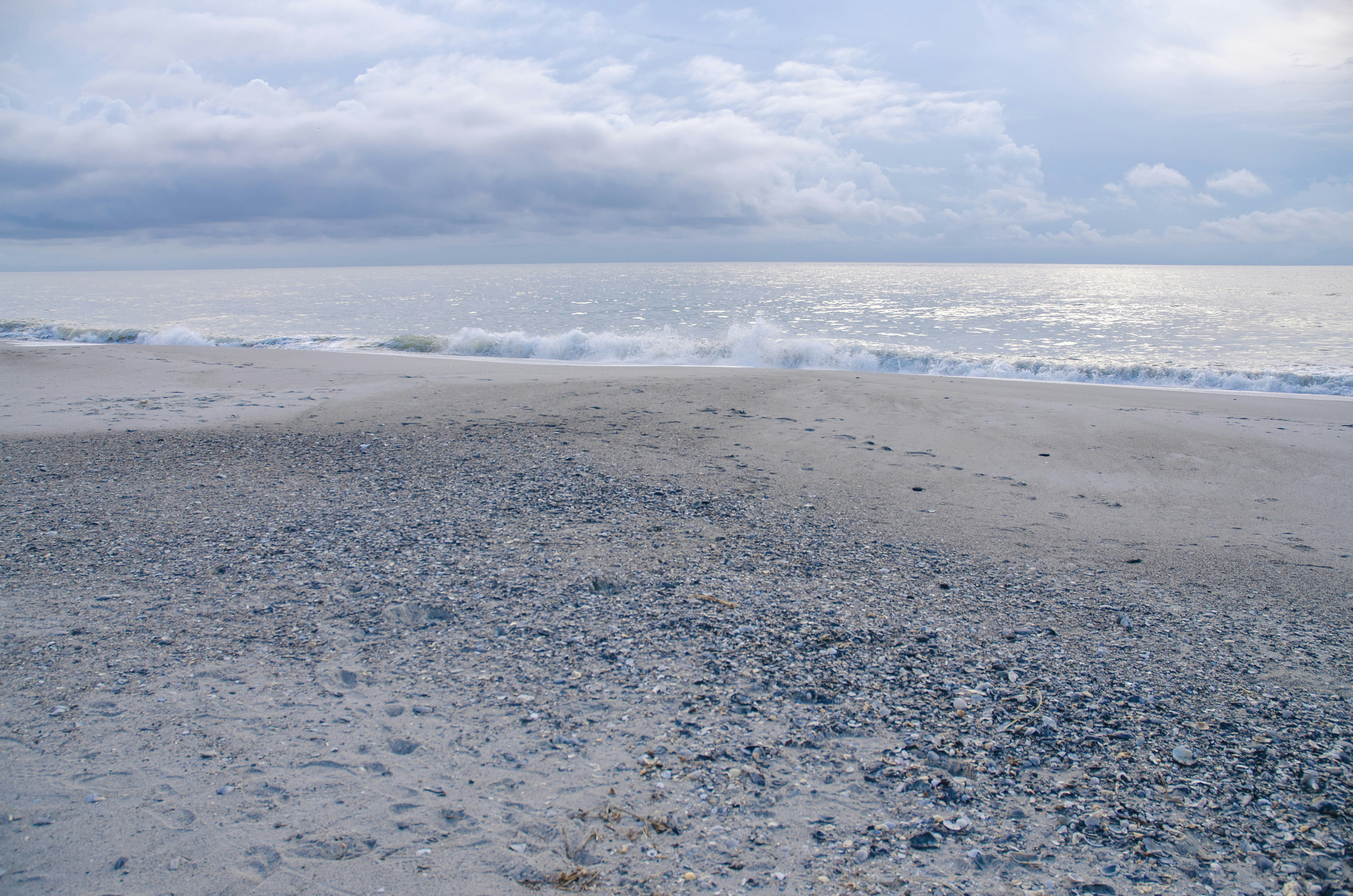 Quiet Foreshore: Pebbles and Calm Horizon