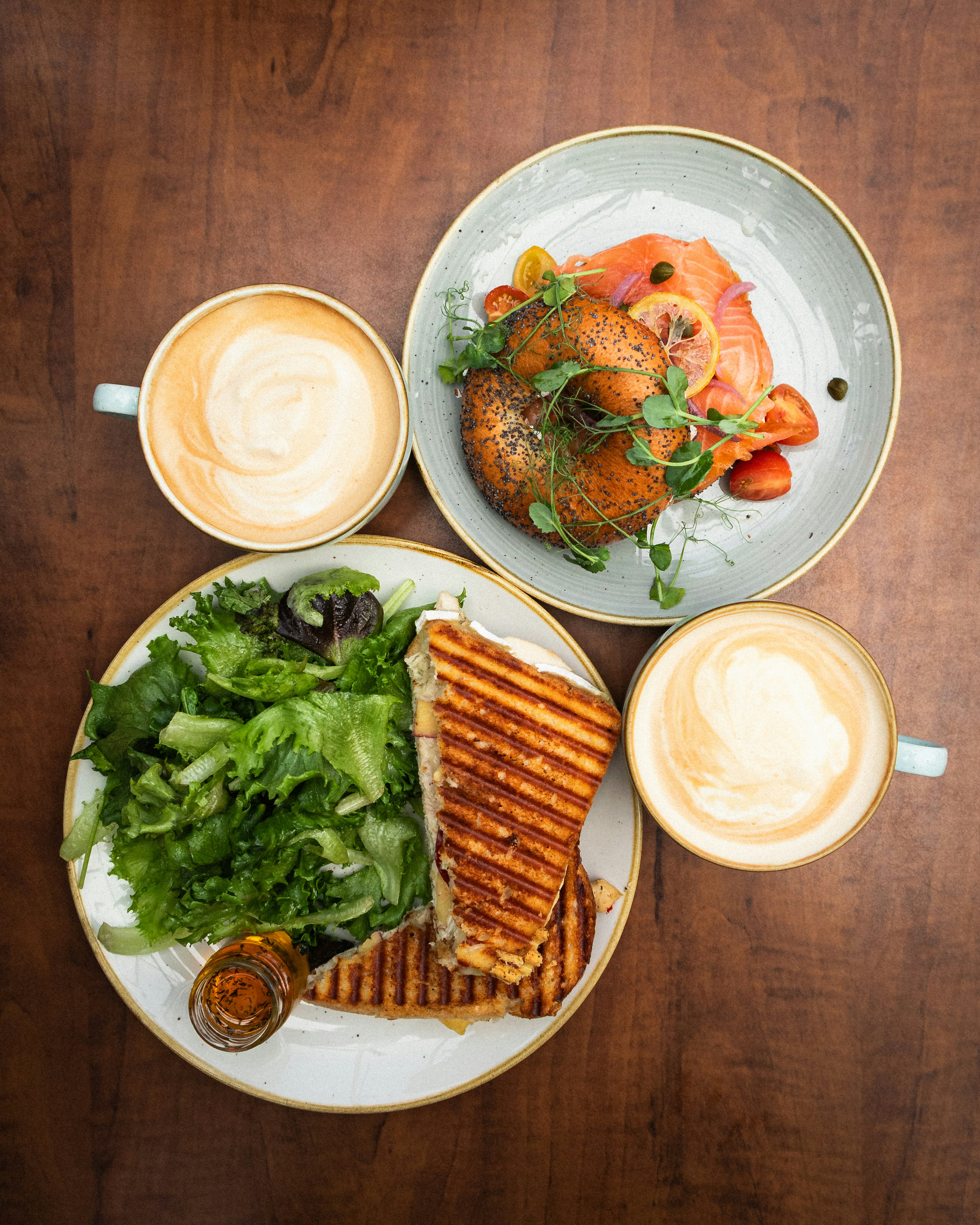 Overhead Café Trio: A Salmon Roulade, Grilled Panini, and Foam