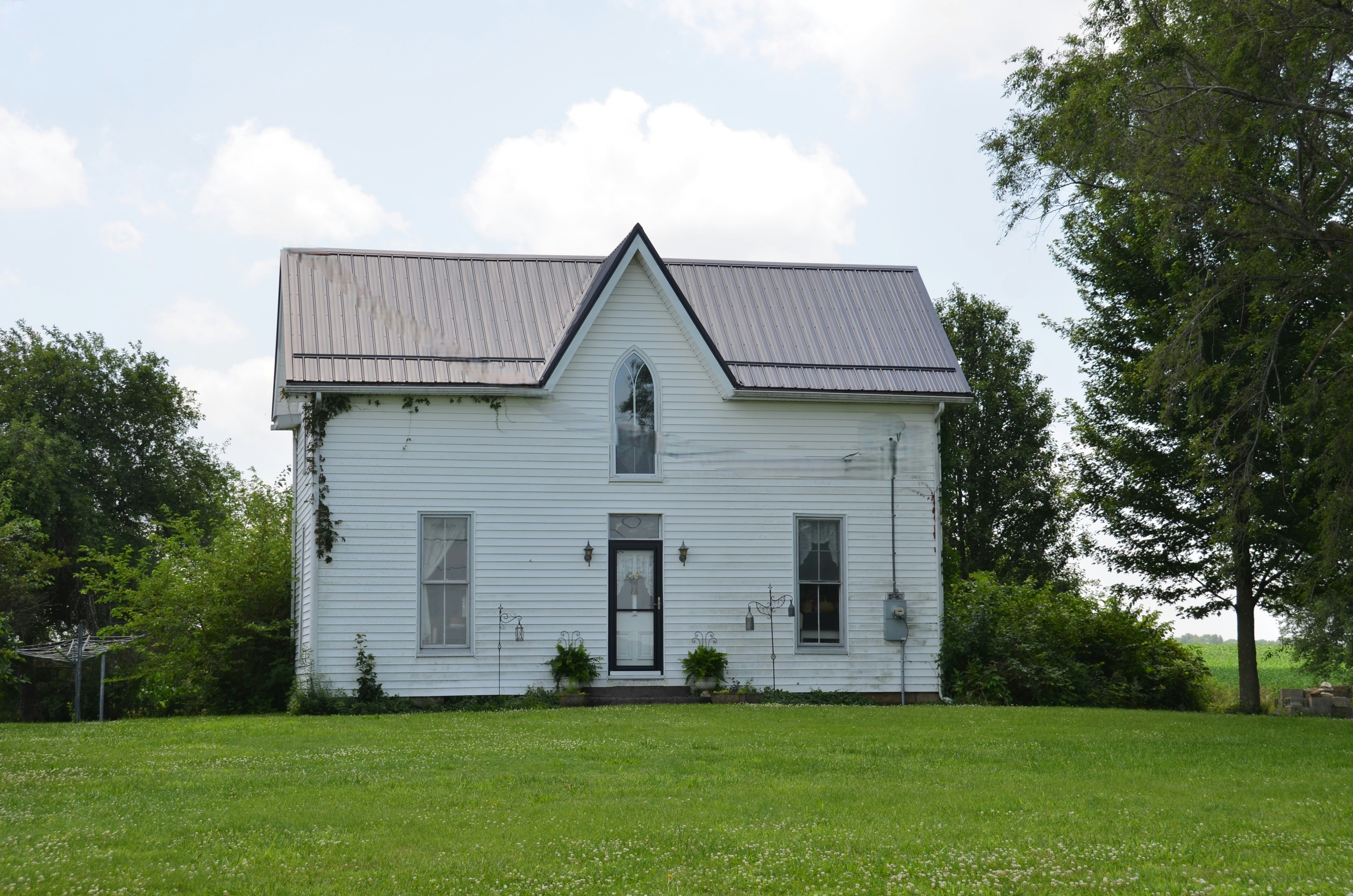 White A-frame Cottage Standing Proud on a Verdant Lawn