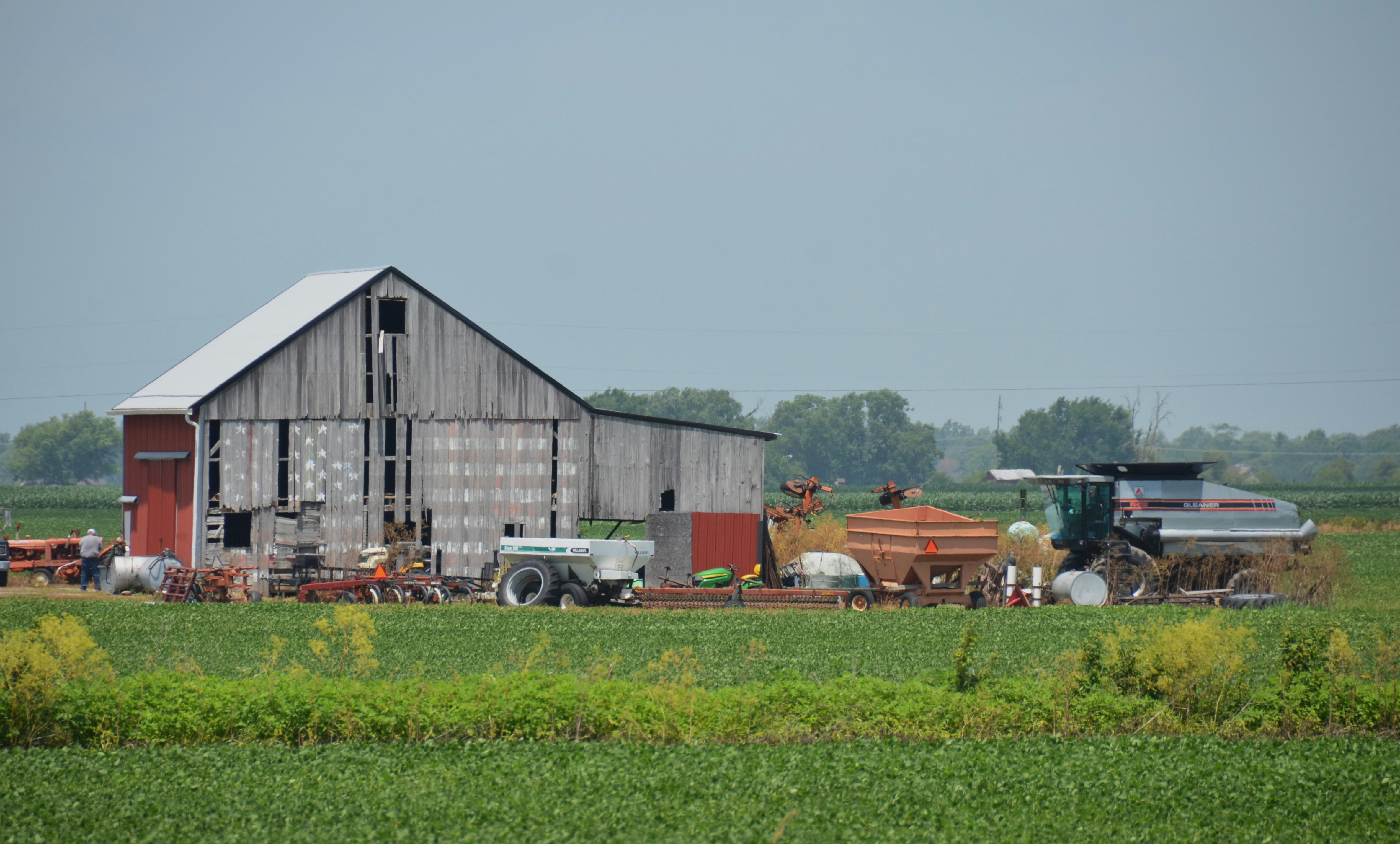Weathered Barn and Farm Equipment on Quiet Midwestern Field