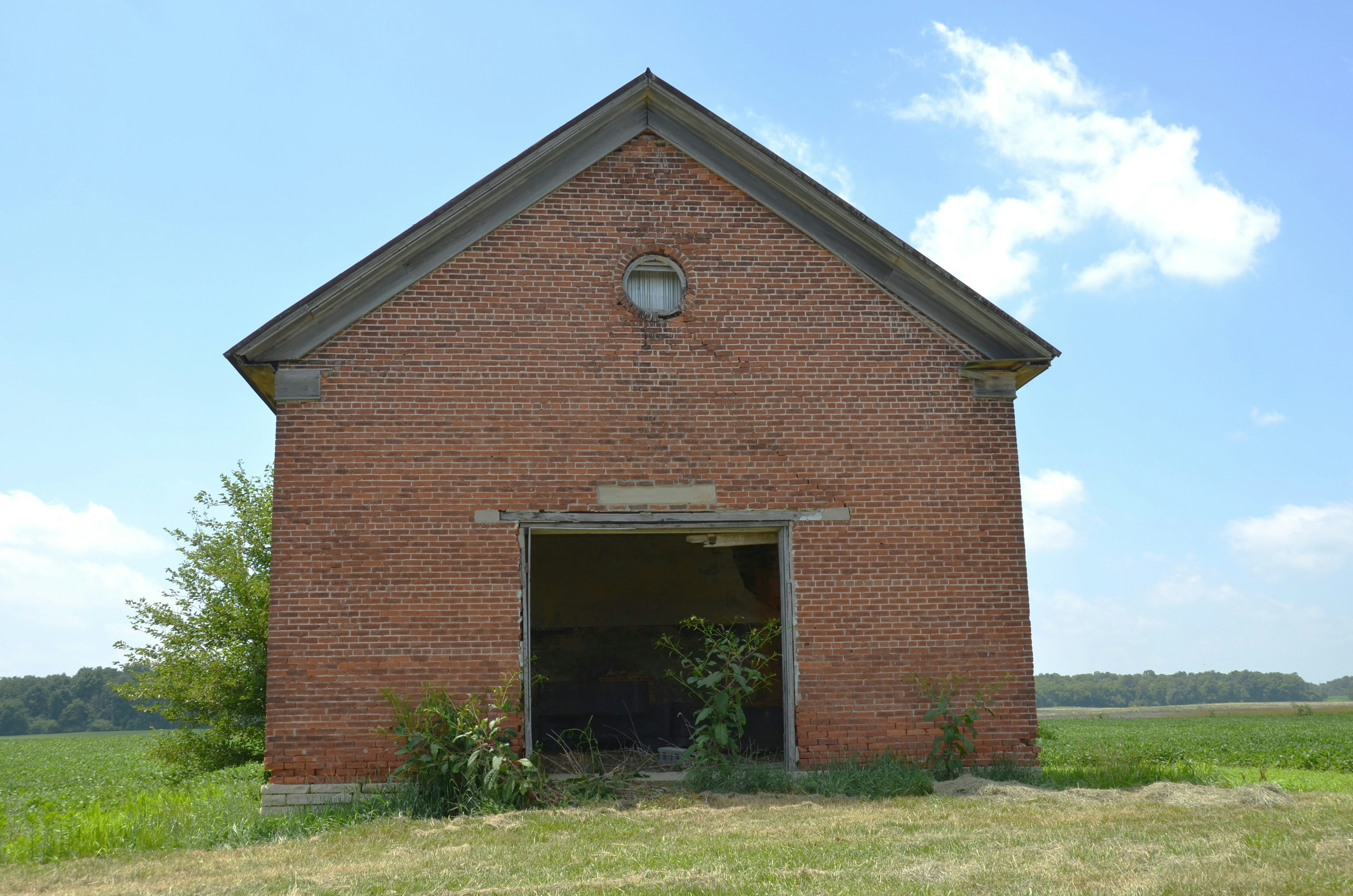 Old Barn Facade Surrounded by Wide Open Fields