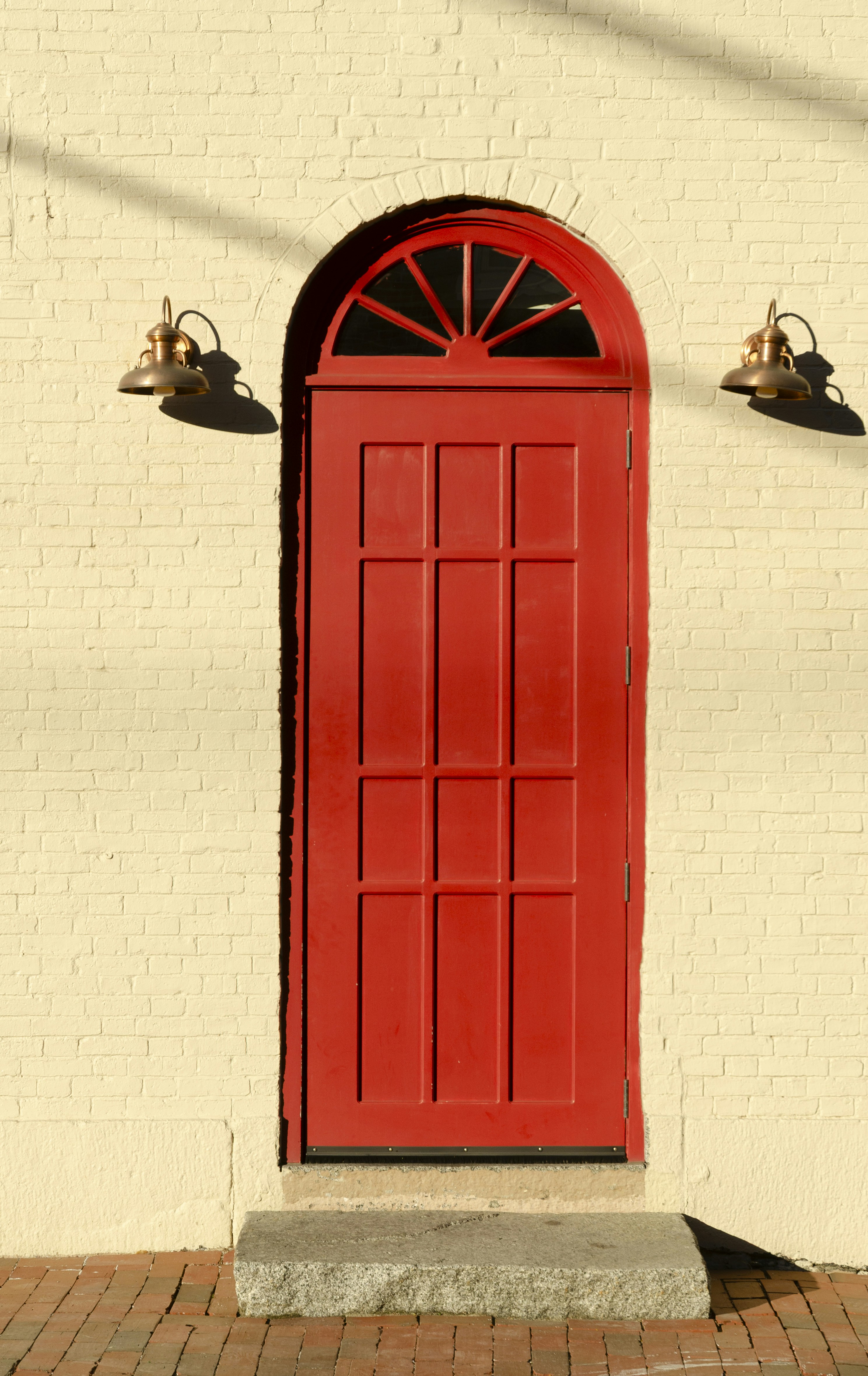Crimson Door in Sunlit Beige Brick Walkway