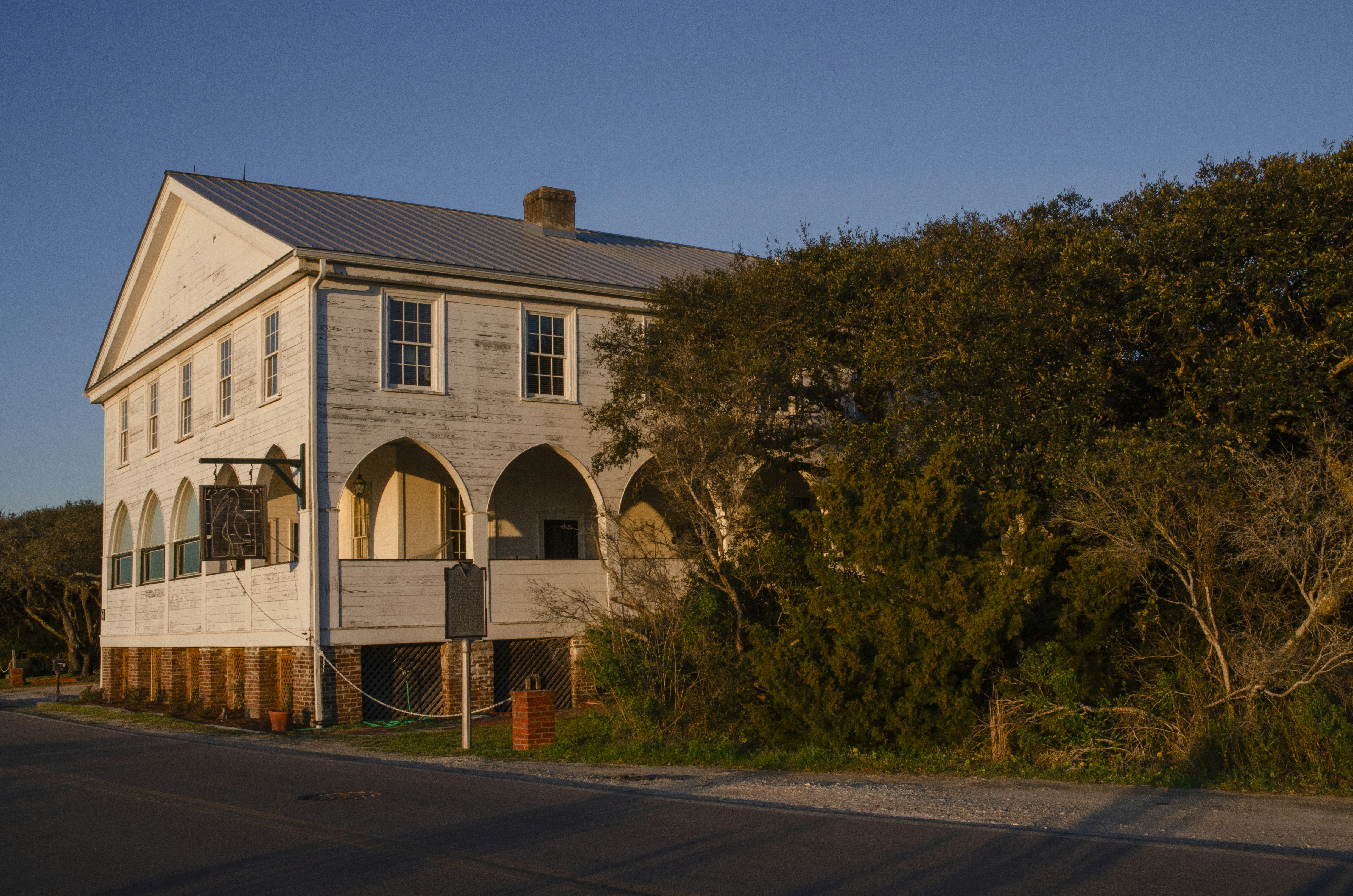 Old Depot at Dusk: Arched Facade Under a Growing Canopy