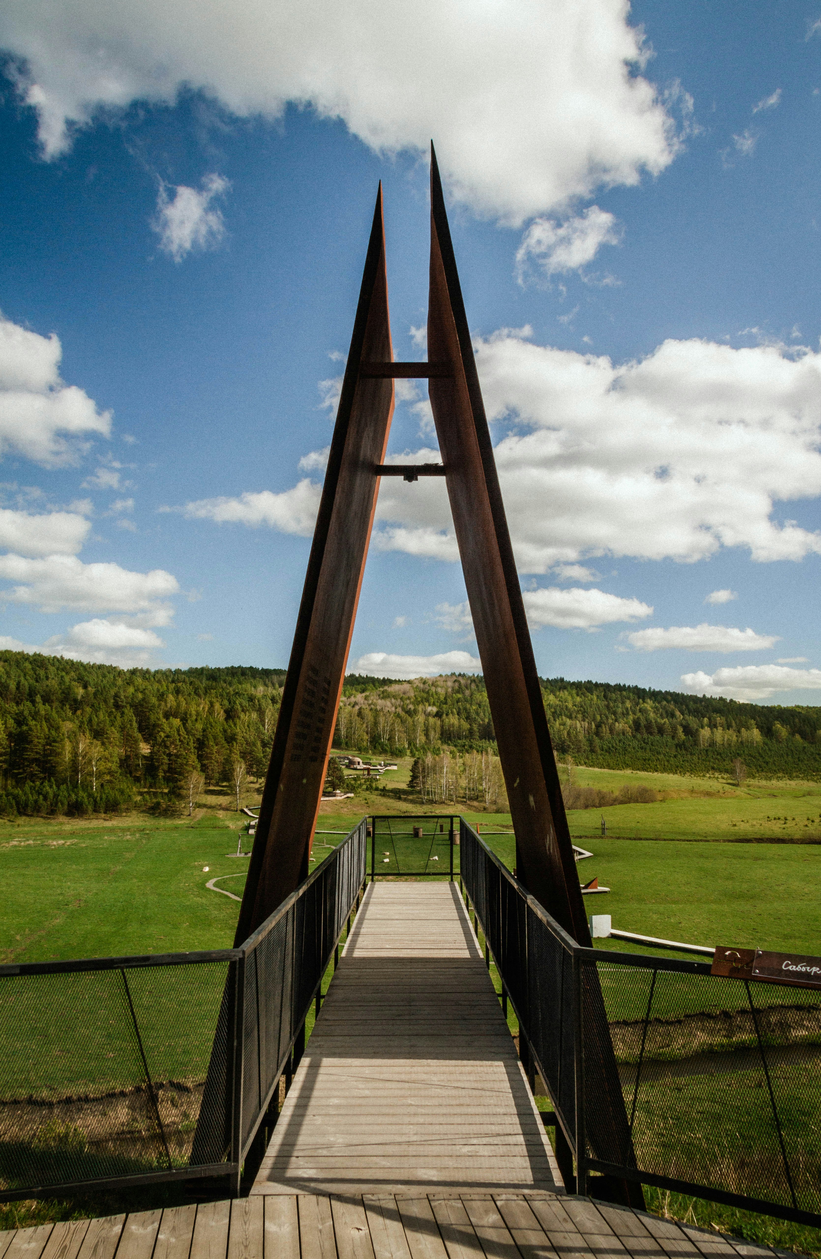 Iron Arc of the Bridge: A steel monument over a green valley
