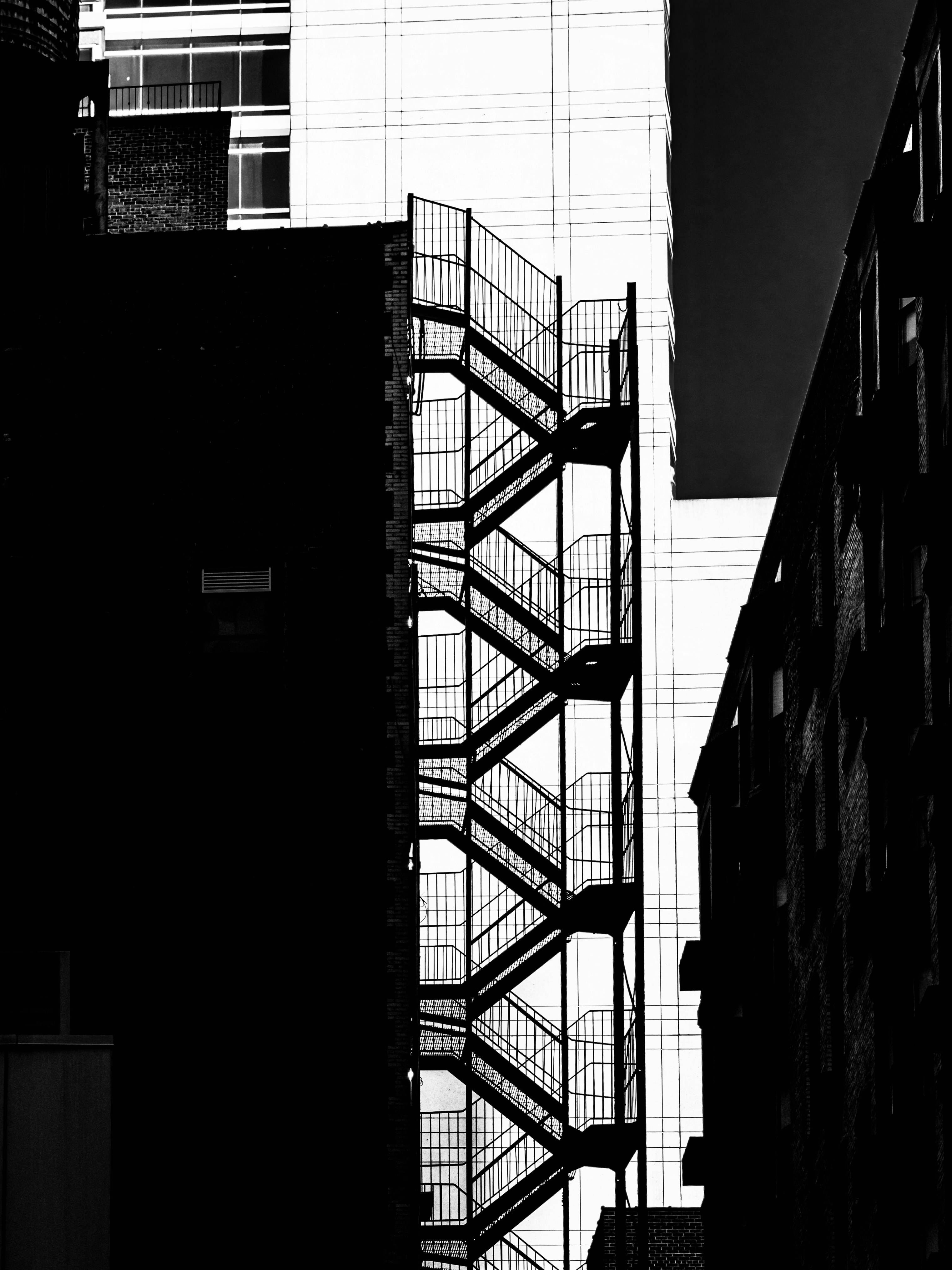 Staircase Geometry Between Dark Block and Bright Facade